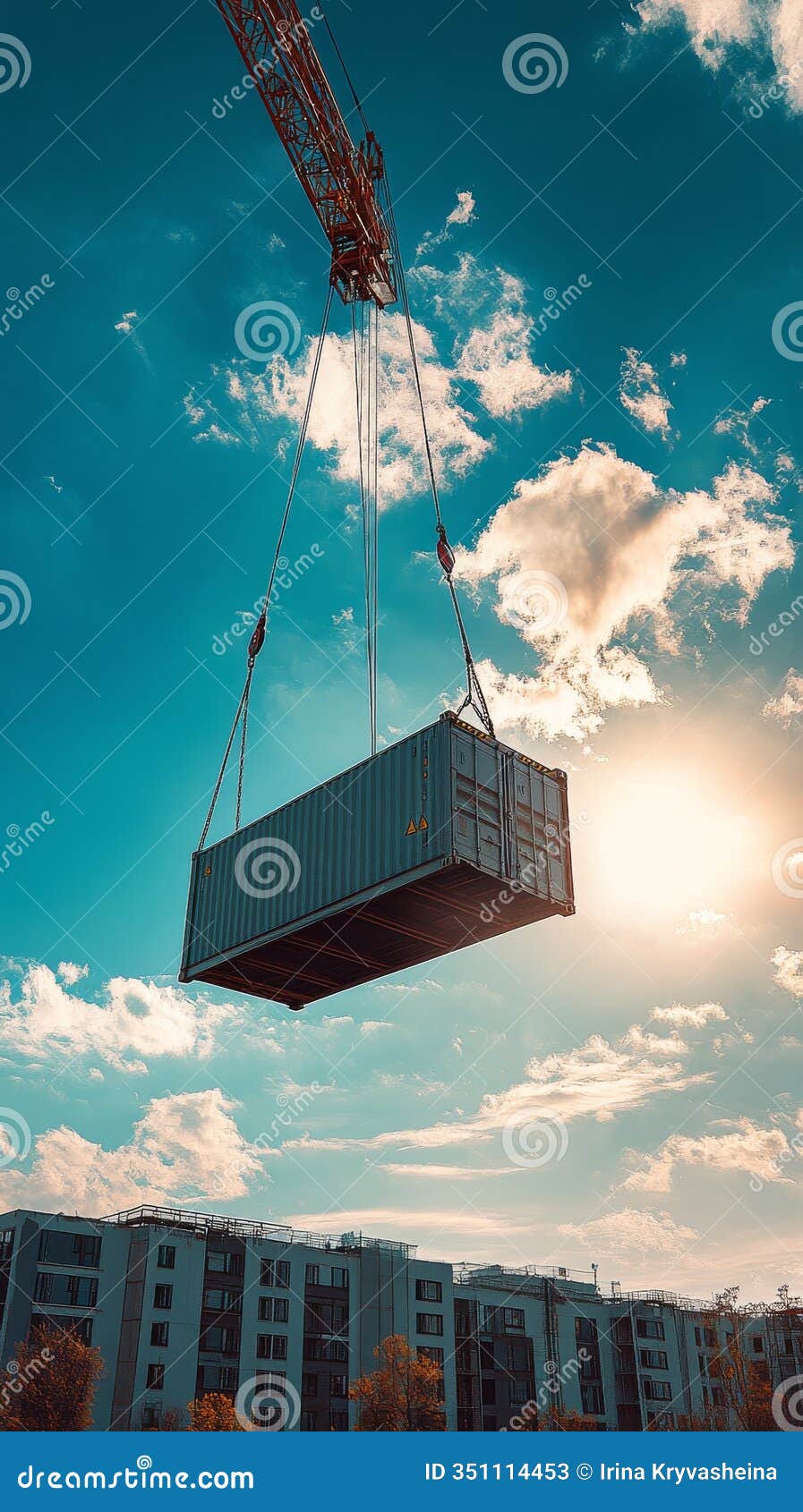 Construction Crane Lifting a Shipping Container at a Building Site ...