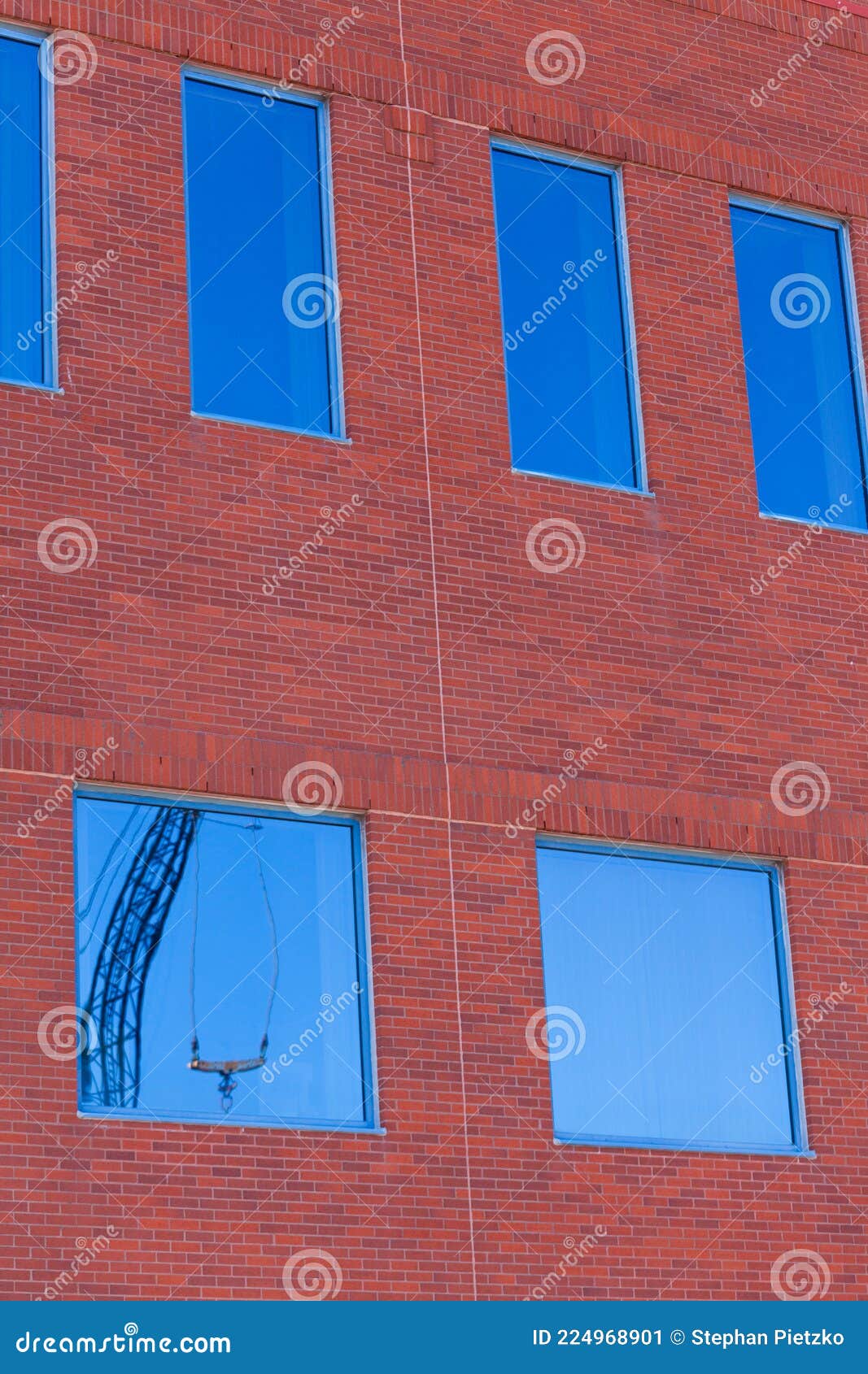 Construction Crane Mirrored in Window Brick Facade Stock Image - Image ...