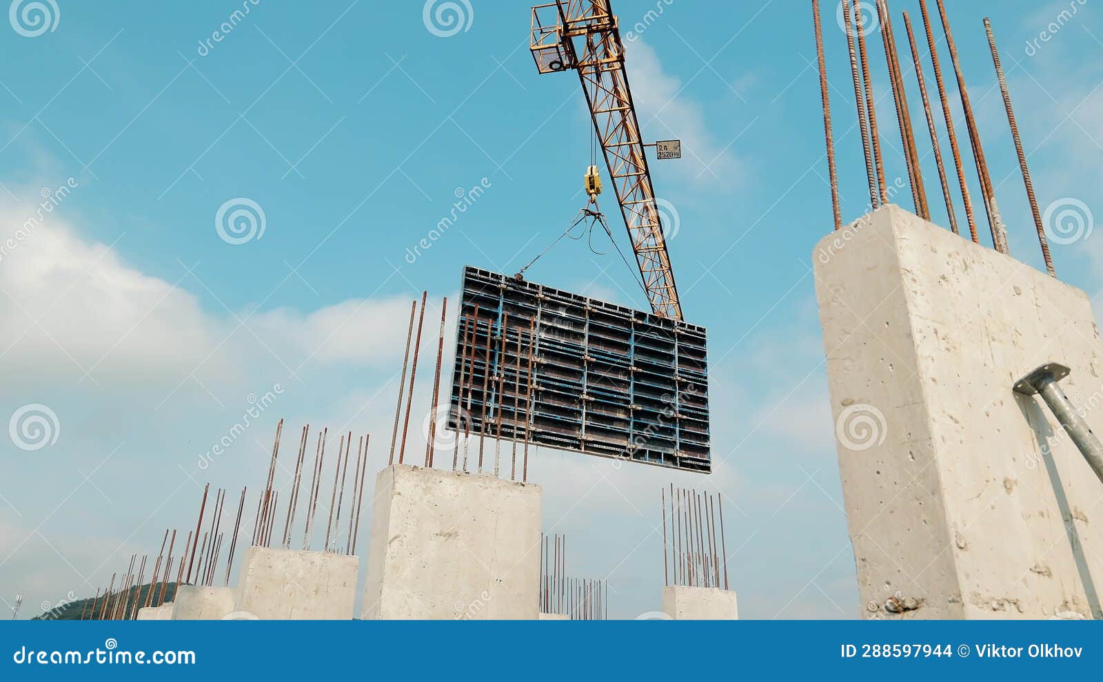 A Construction Crane Moves Cargo during the Construction of a House ...