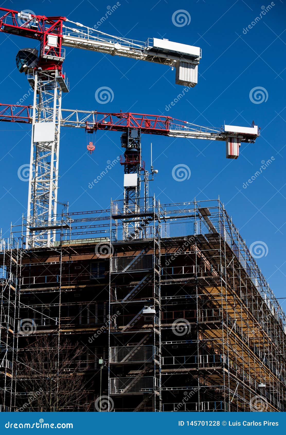 Construction crane working stock photo. Image of apartment - 145701228