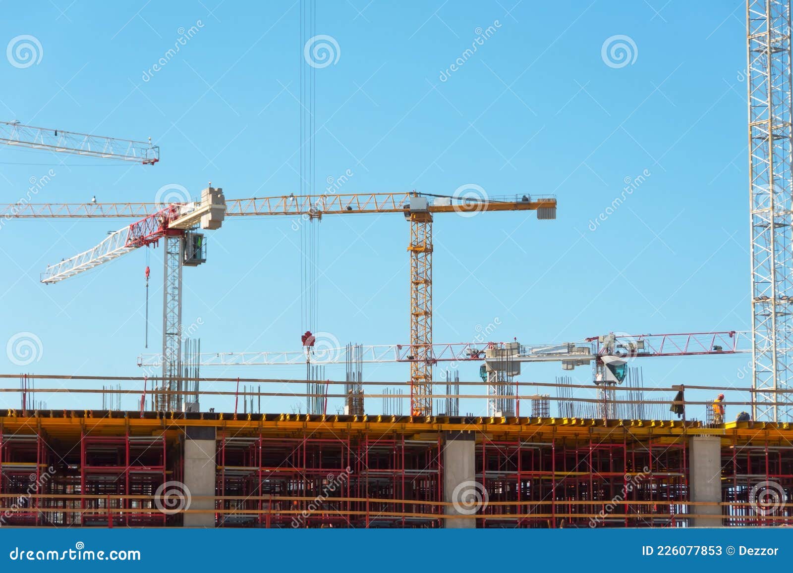 Construction Cranes Above the Construction Site of the Concrete Frame ...