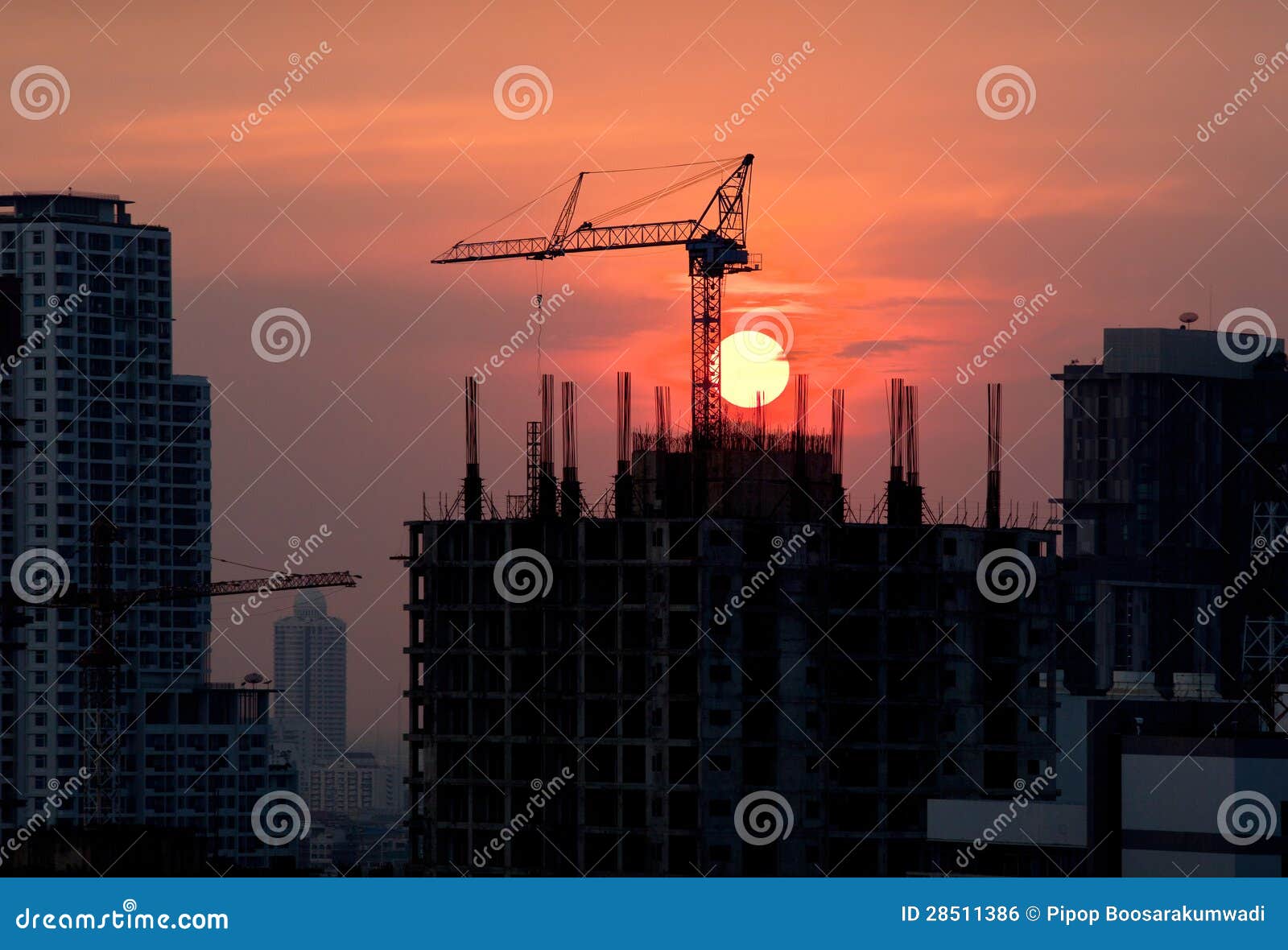 Construction Cranes and Building Silhouettes Over Sun at Sunrise. Stock ...