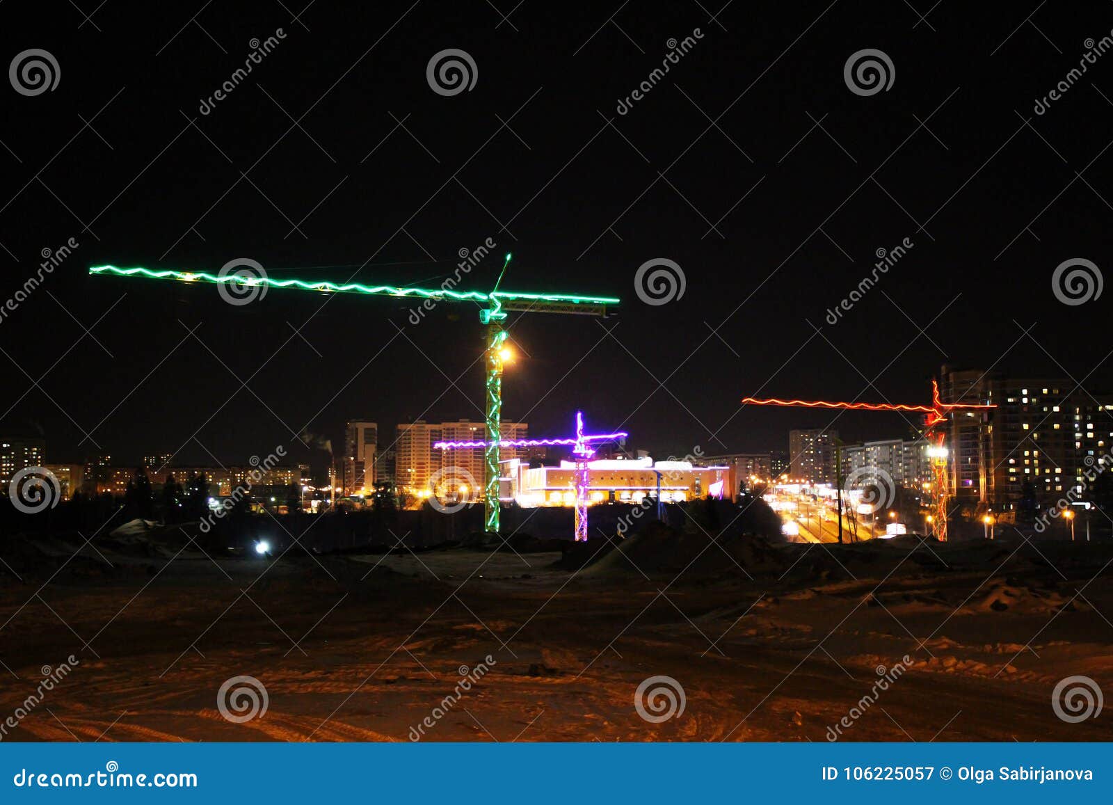 Construction Cranes at a Construction Site, Colored Light at Night ...