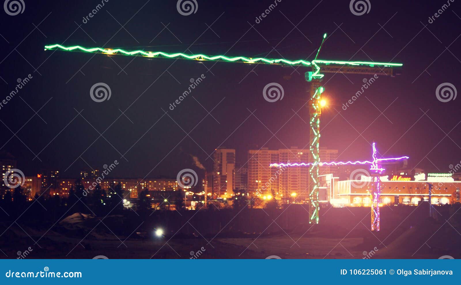 Construction Cranes at a Construction Site, Colored Light at Night ...