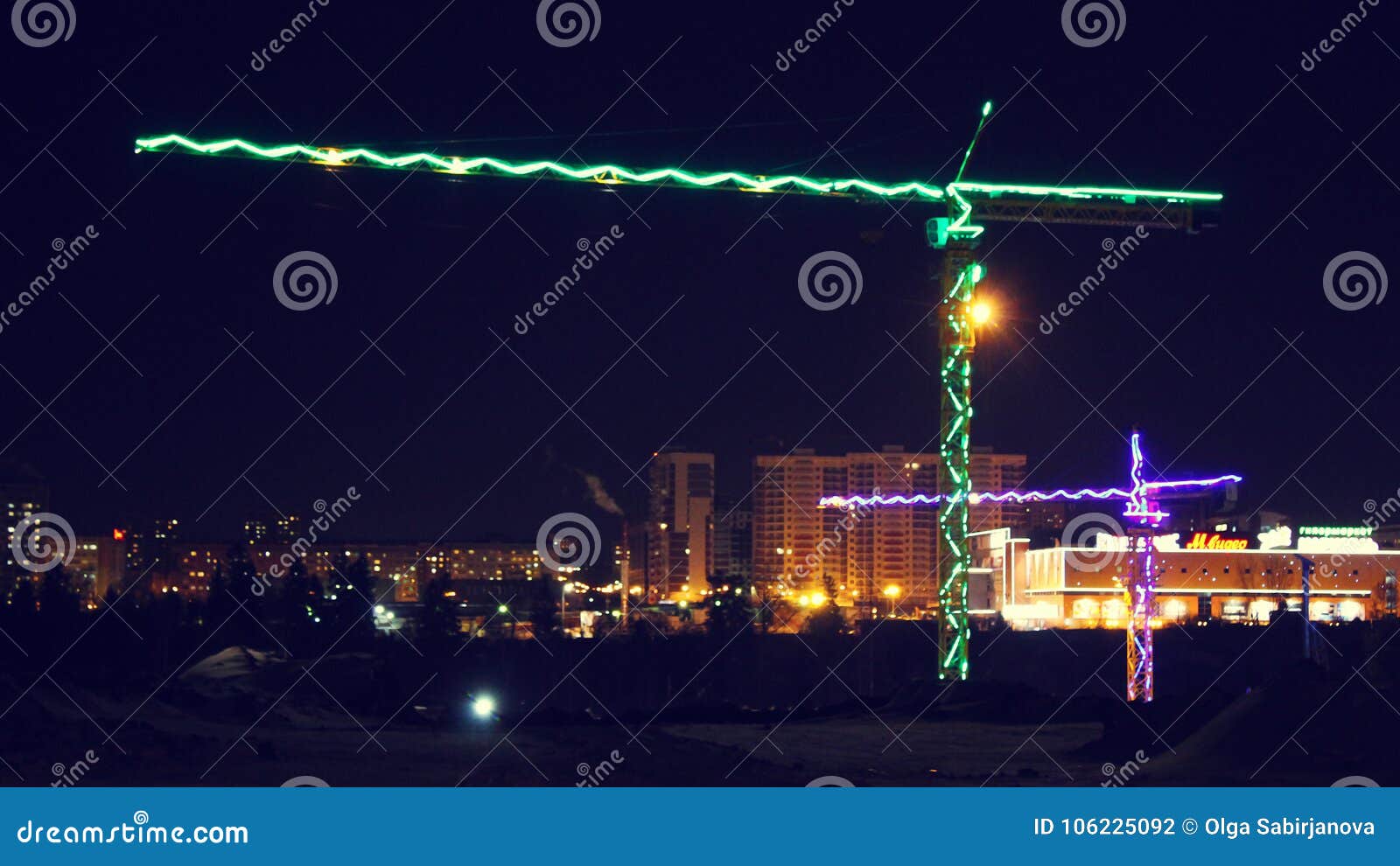 Construction Cranes at a Construction Site, Colored Light at Night ...
