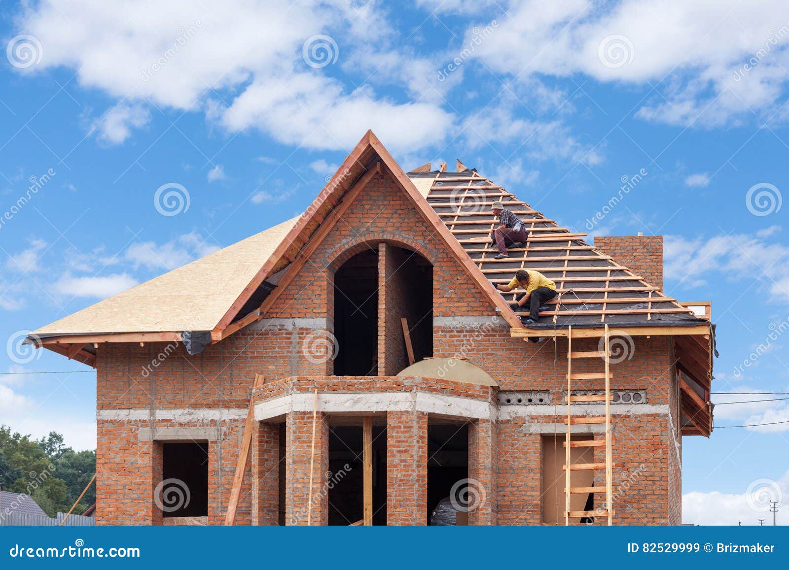 Construction Crew Working On The Roof Sheeting Of New House Made With ...