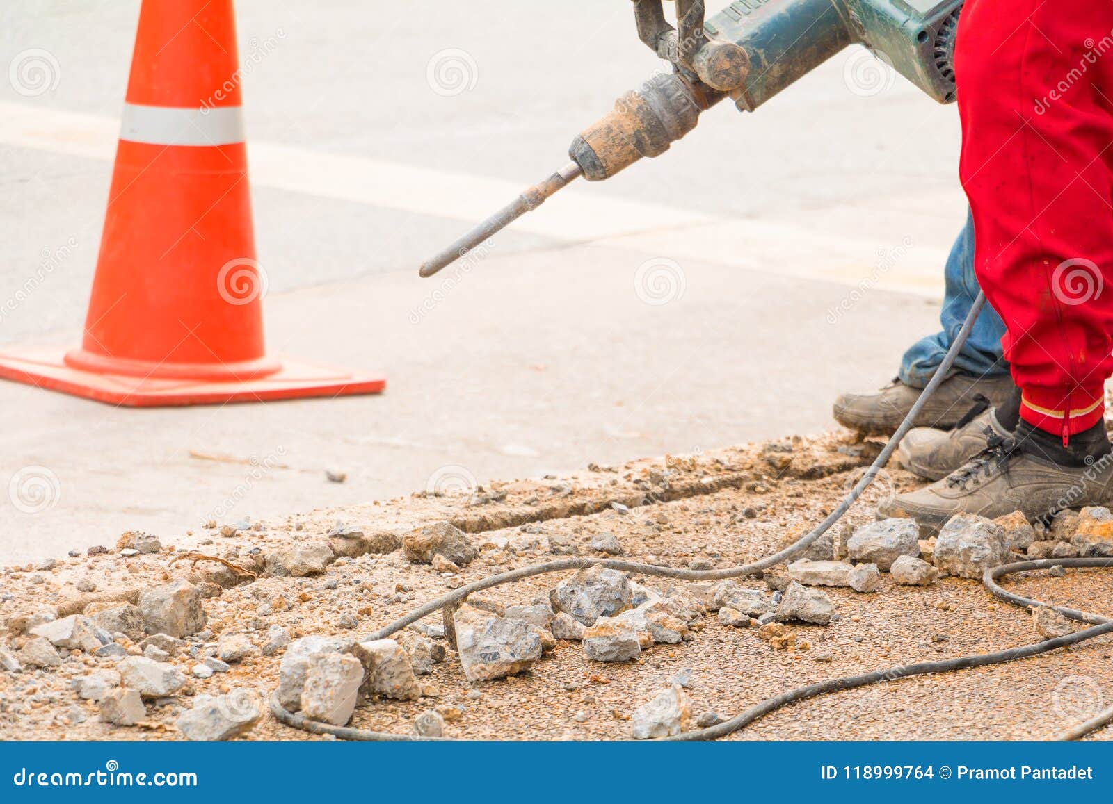 Construction Drilling Repair Worker on Road Surface with Heavy Duty ...