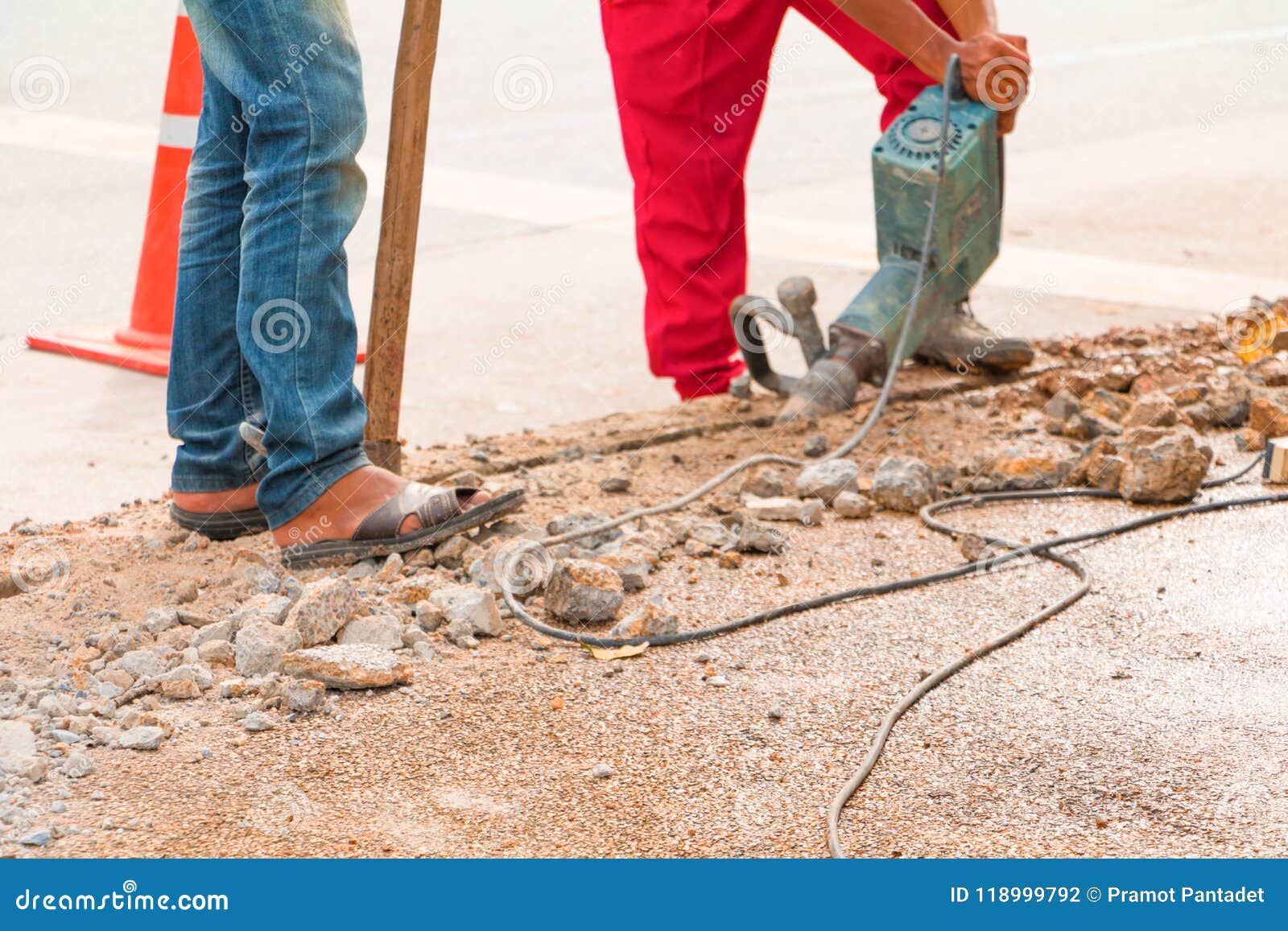 Construction Drilling Repair Worker on Road Surface with Heavy Duty ...