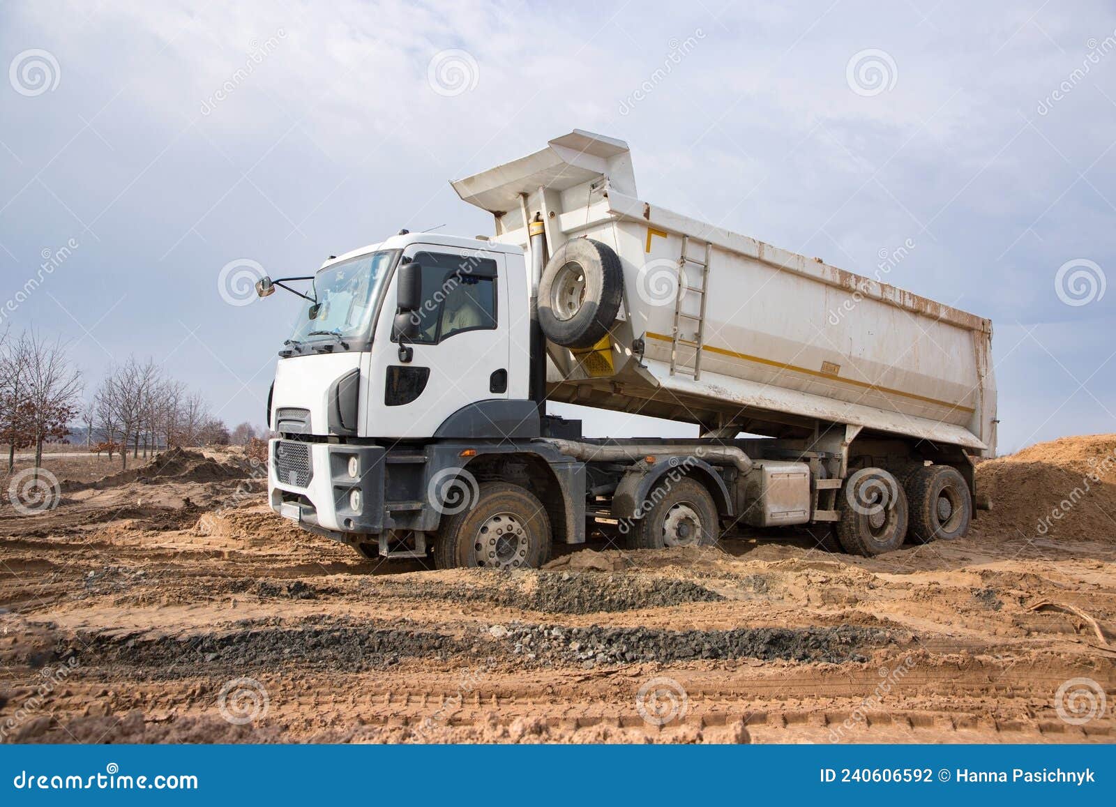 Construction Dump Truck Performs Excavation Work on a Construction Site ...