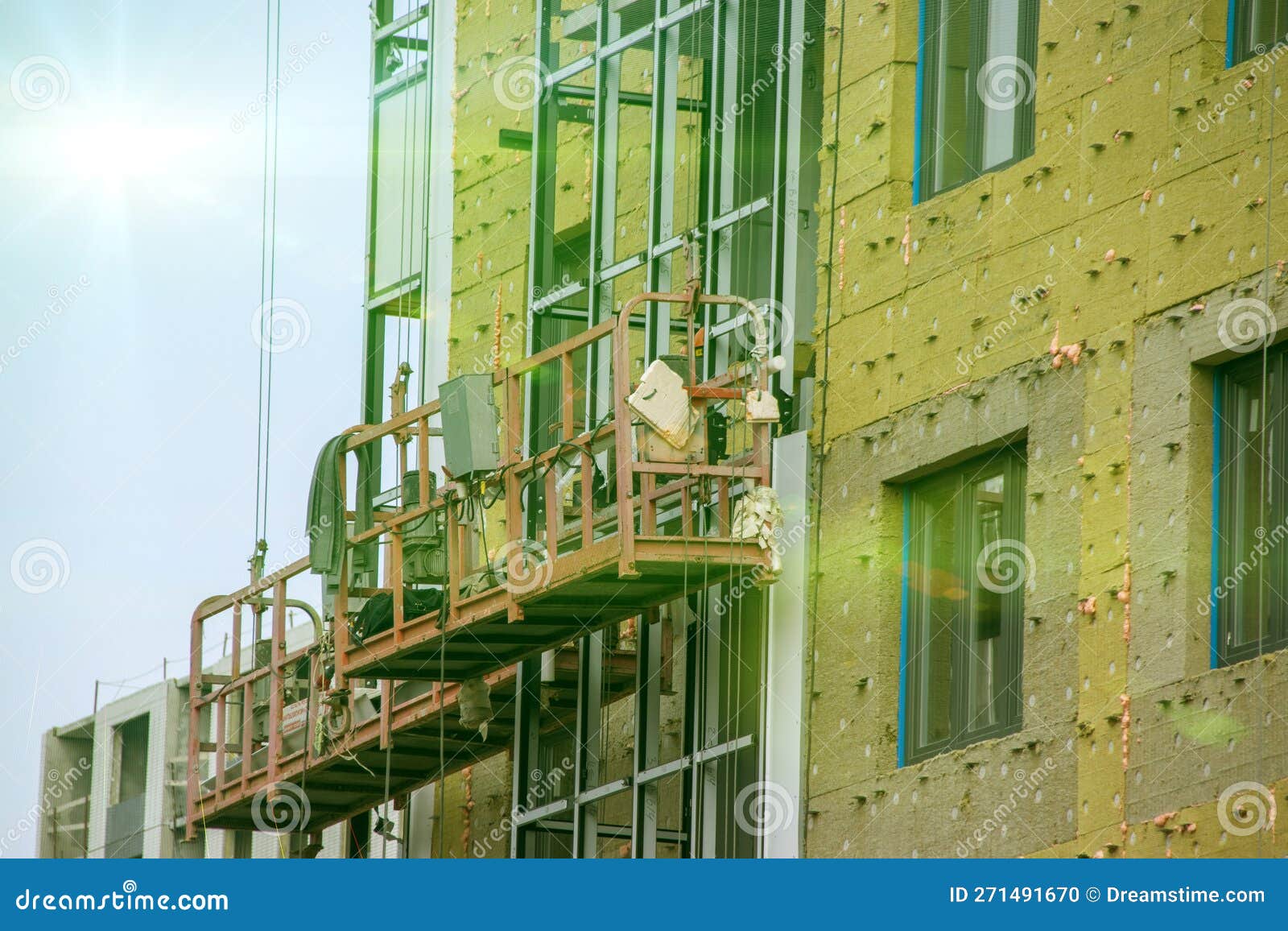 Construction Elevator on the Facade of the Building for Insulation on a ...