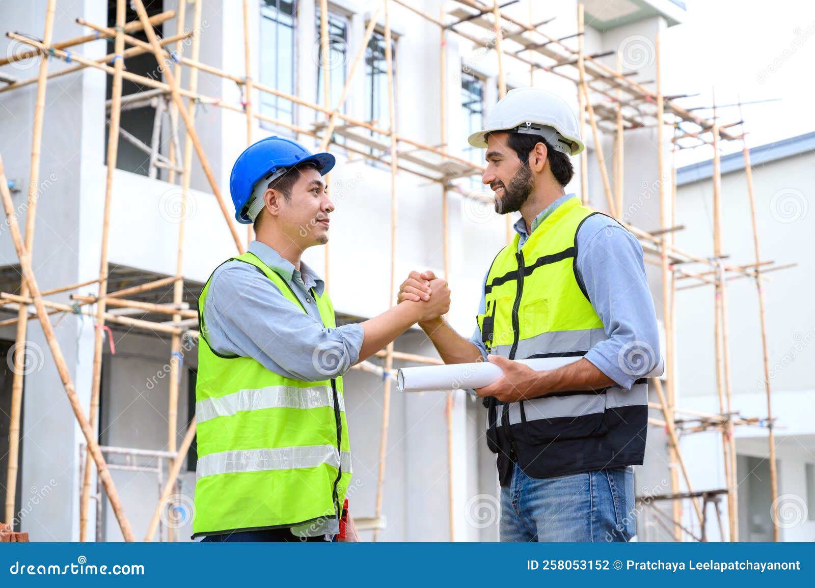 Construction Engineer and Architect with Blueprint Shaking Hands while ...