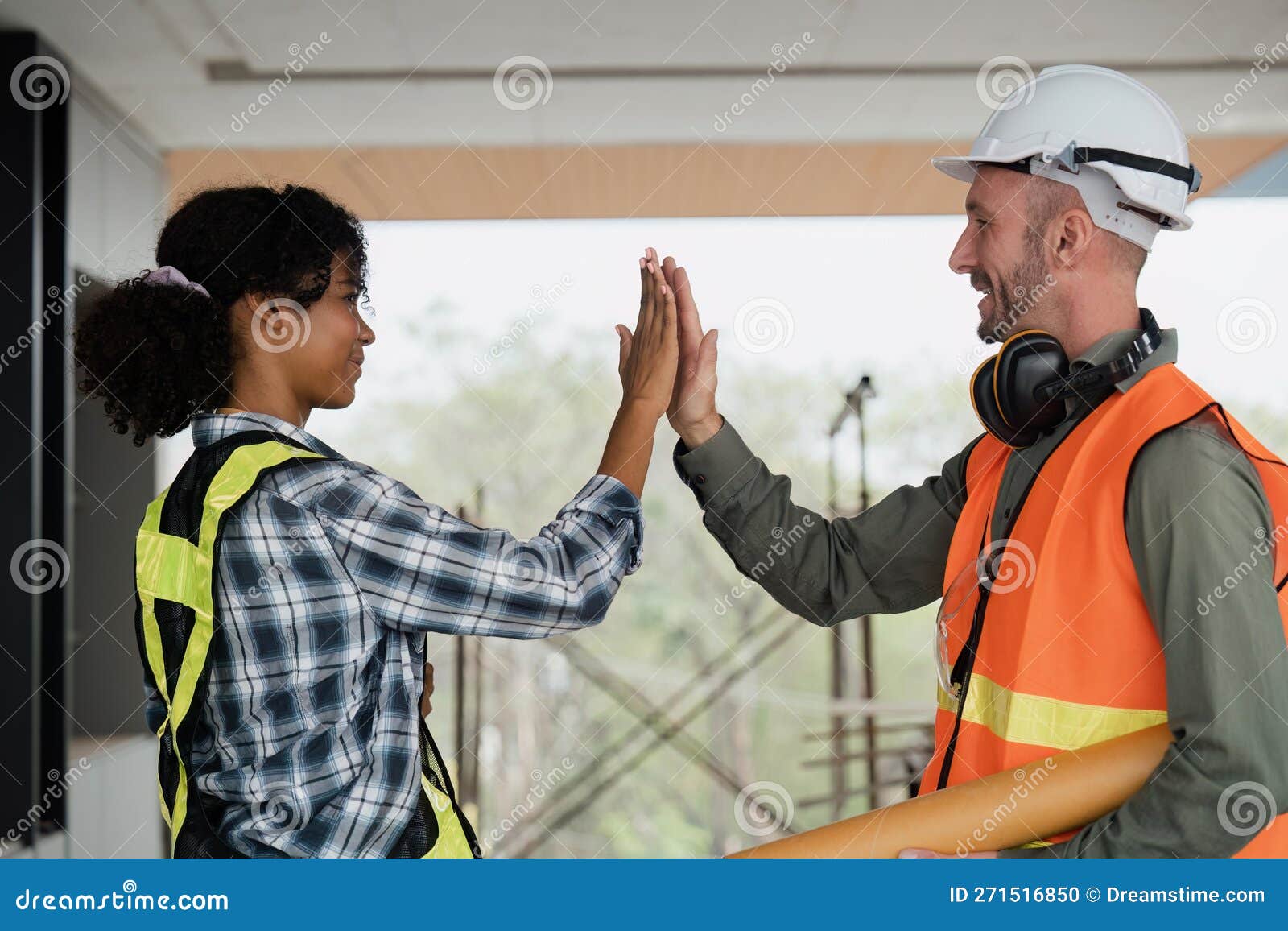 Construction Engineer with Blueprint Making High Five while Standing on ...
