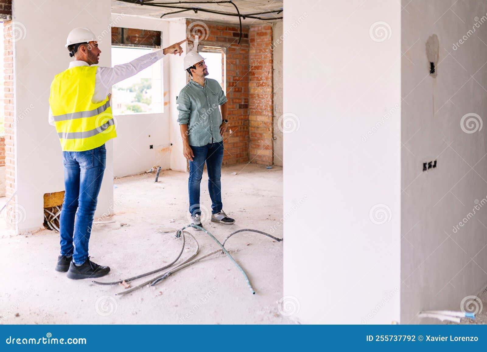 Construction Engineer Discussing with Architect Worker at Indoor ...