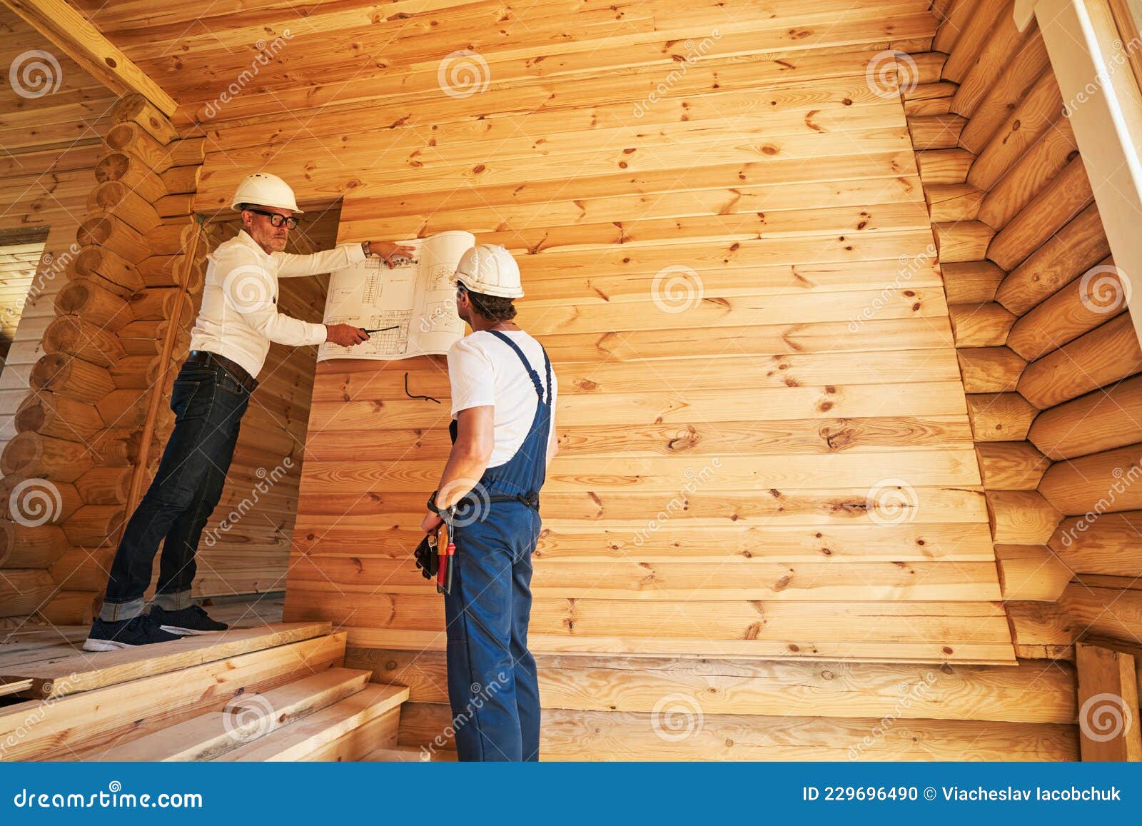 Housebuilder With Drawings In Arms Leaning On Porch Railings Royalty ...