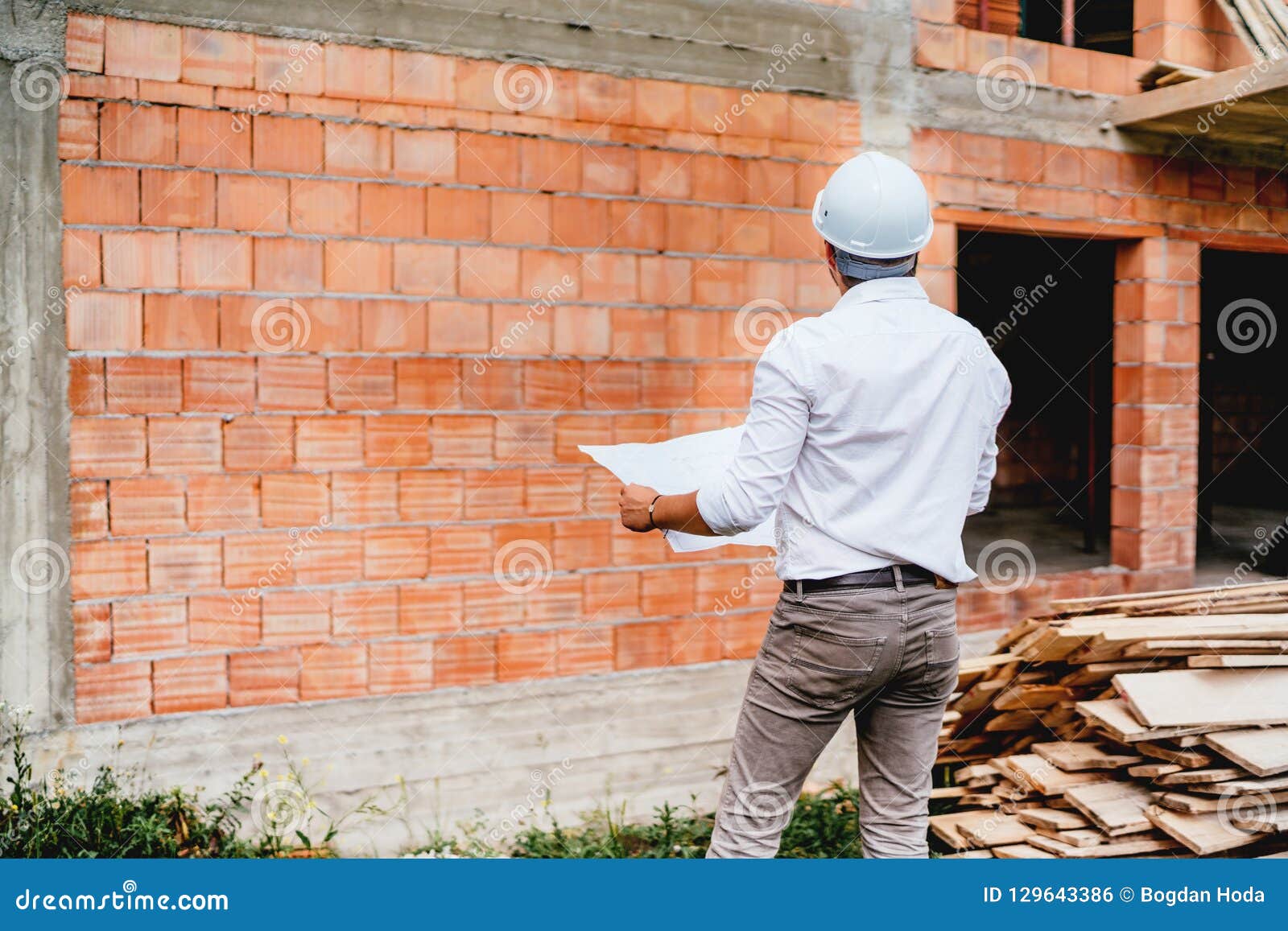 Construction Engineer with Plans, Working on Building Construction Site ...