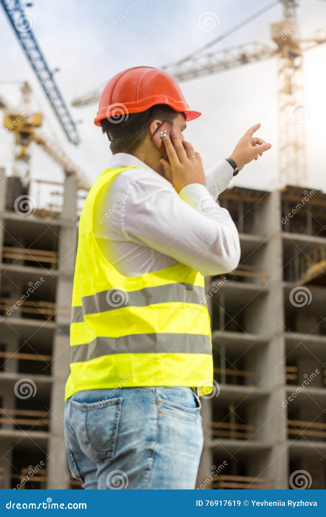 Construction Engineer Pointing with Finger at Building Under Con Stock ...