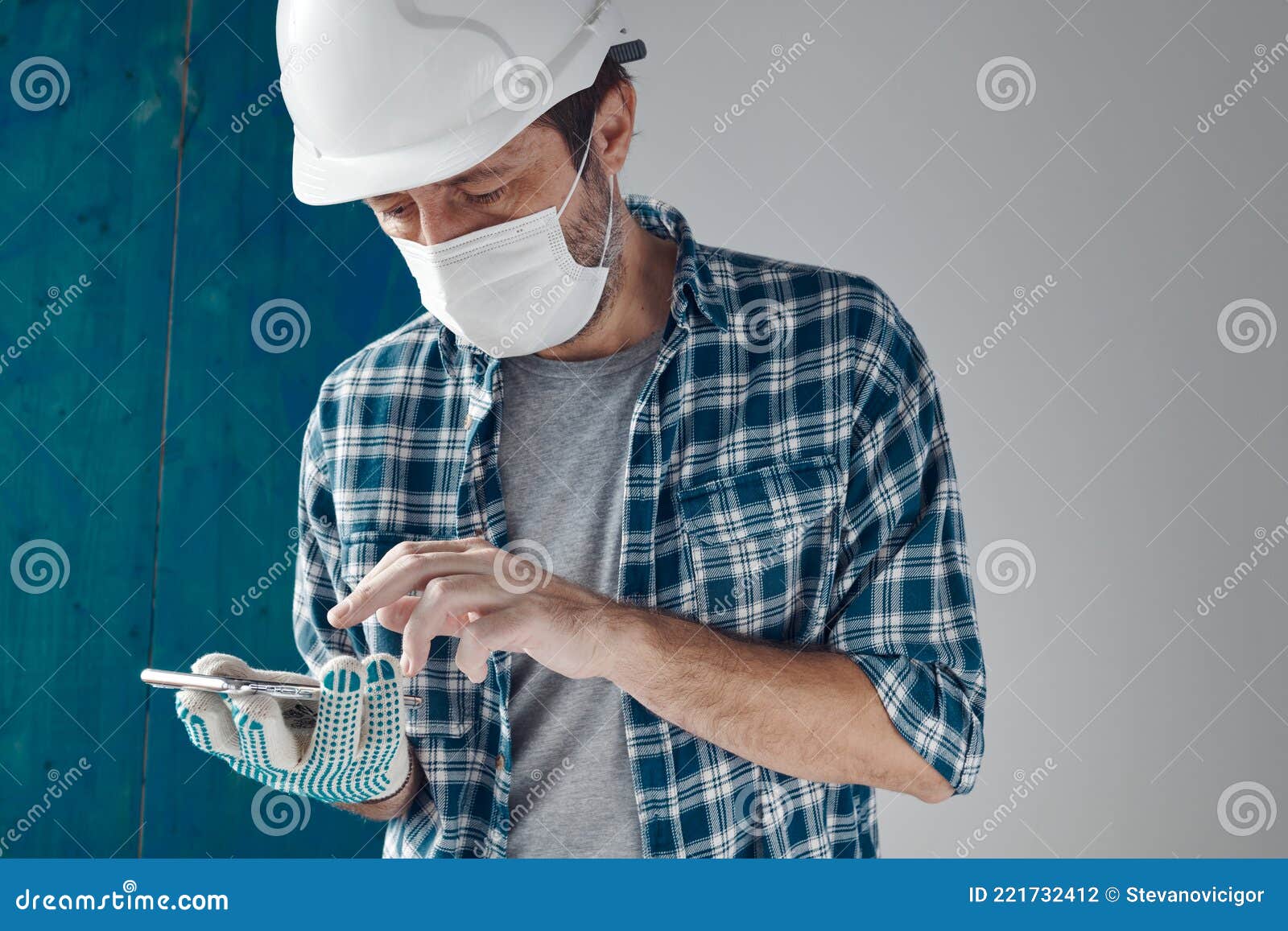 Construction Engineer with Protective Face Mask Text Messaging on ...