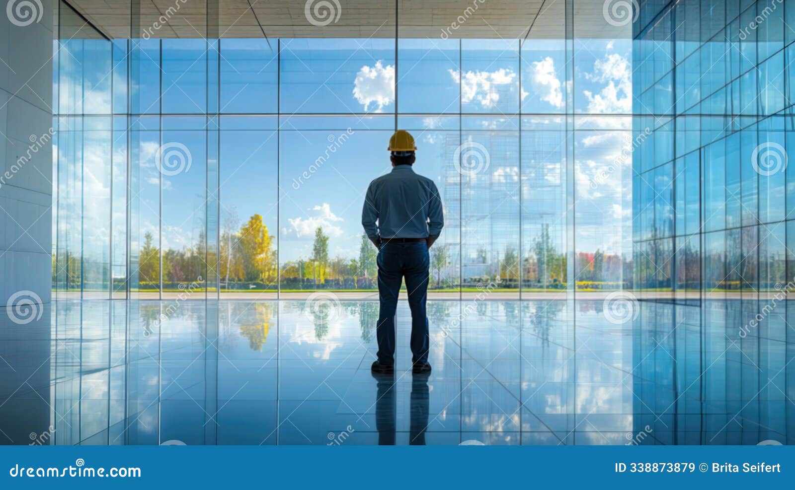 Construction Engineer Standing on the Floor of a Ceiling-level Glass ...