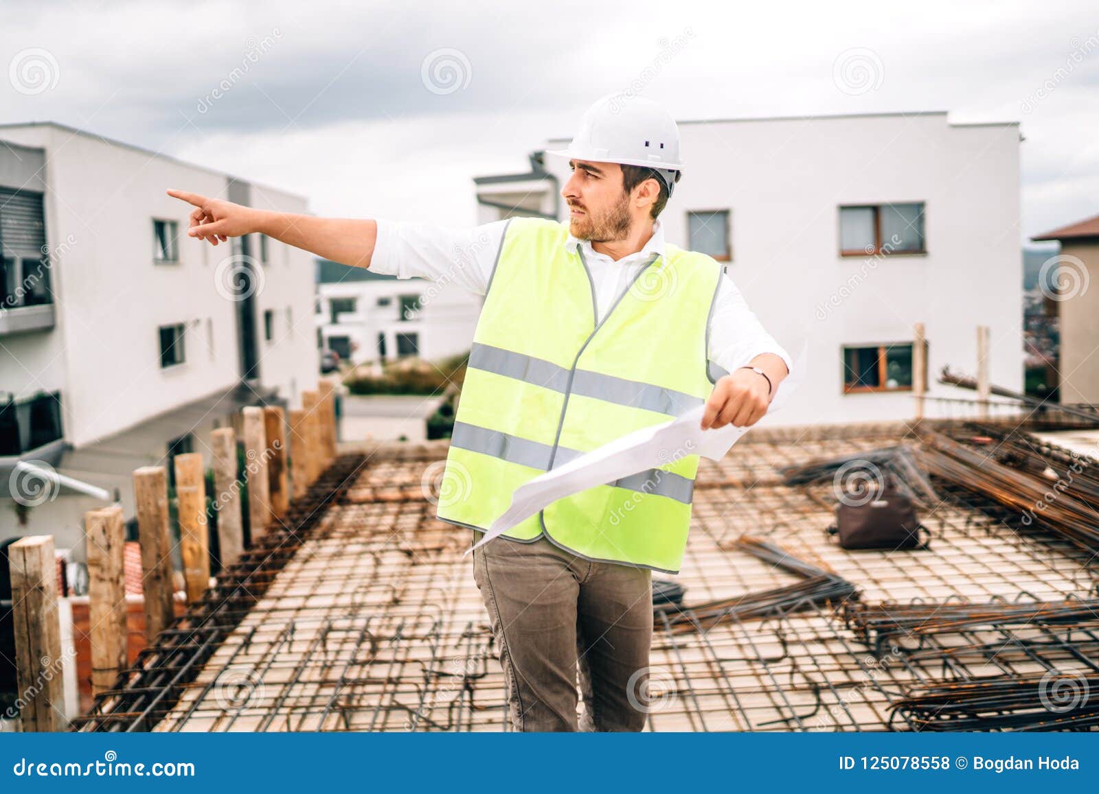 Construction Engineer Working on Construction Site, Pointing and ...