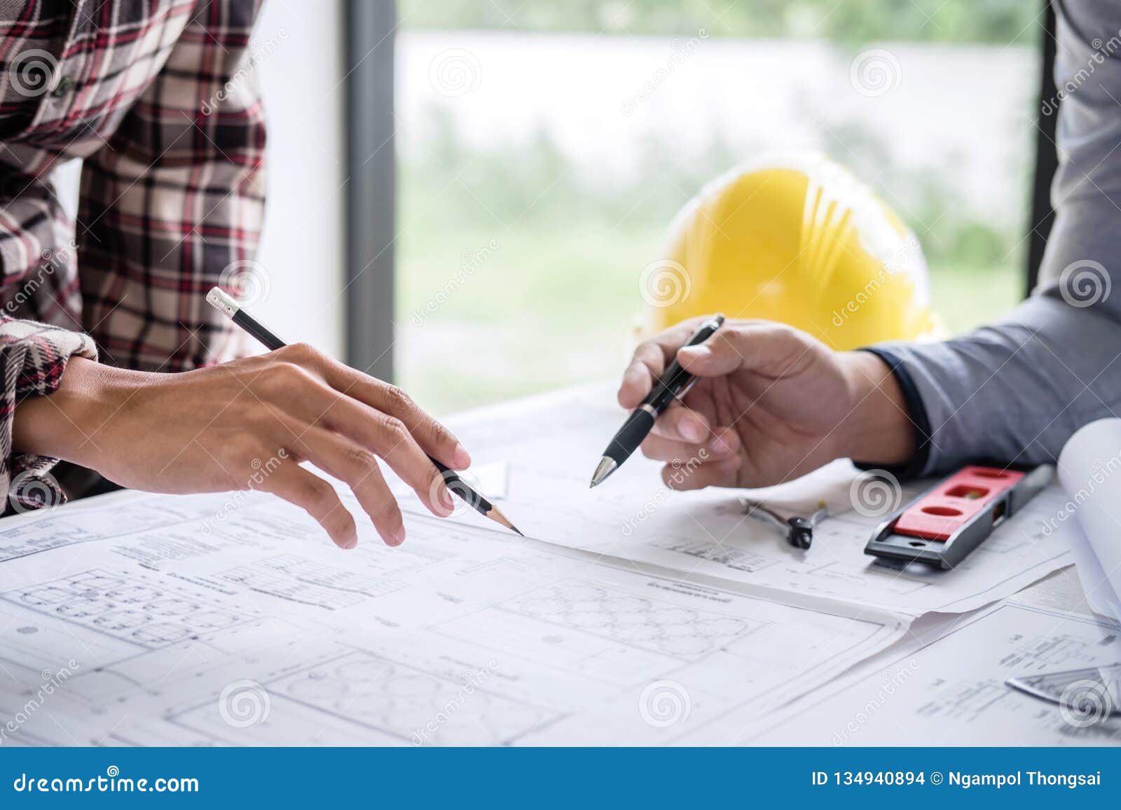 Construction Engineering or Architect Discuss a Blueprint while ...
