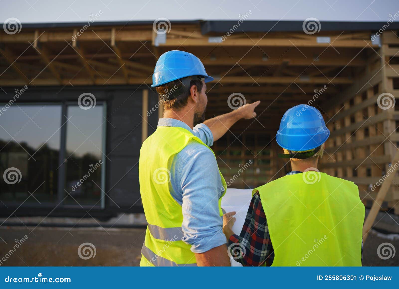 Construction Engineers or Architects with Blueprints Checking Eco ...
