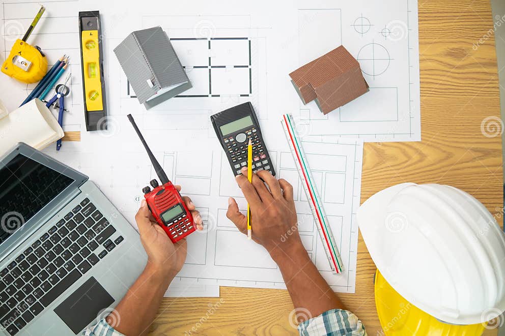 Construction Engineers are Checking Blueprints and Calculating Their ...
