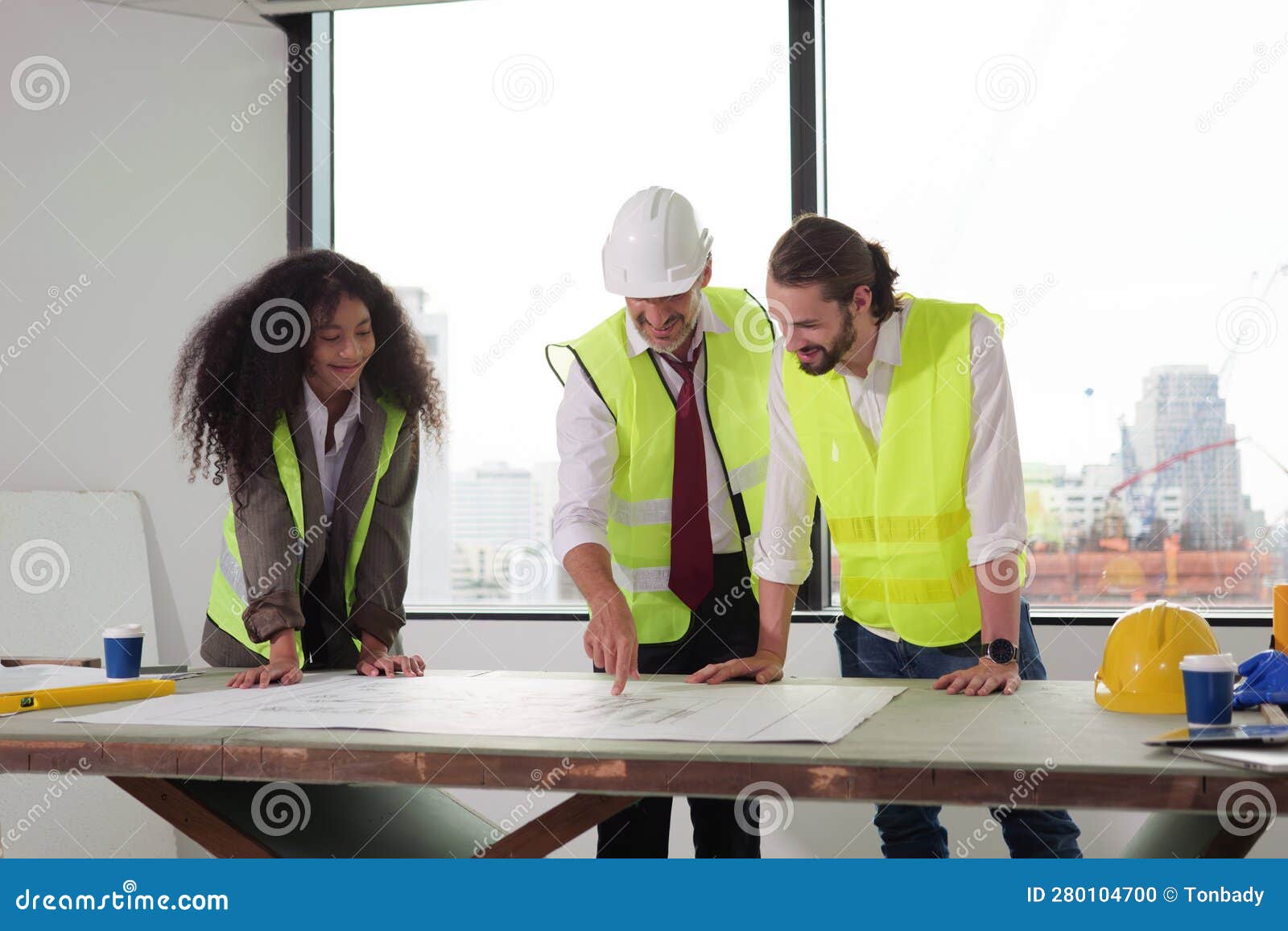 Construction Engineers Team Using Blueprint of Project Plan Stock Photo ...