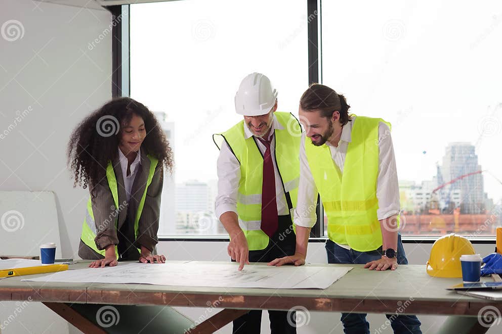 Construction Engineers Team Using Blueprint of Project Plan Stock Photo ...