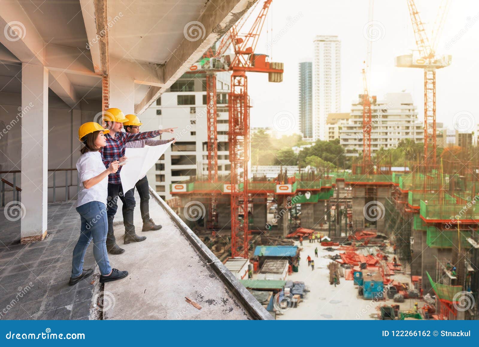 3 Construction Engineers Working Together in Construction Site D Stock ...