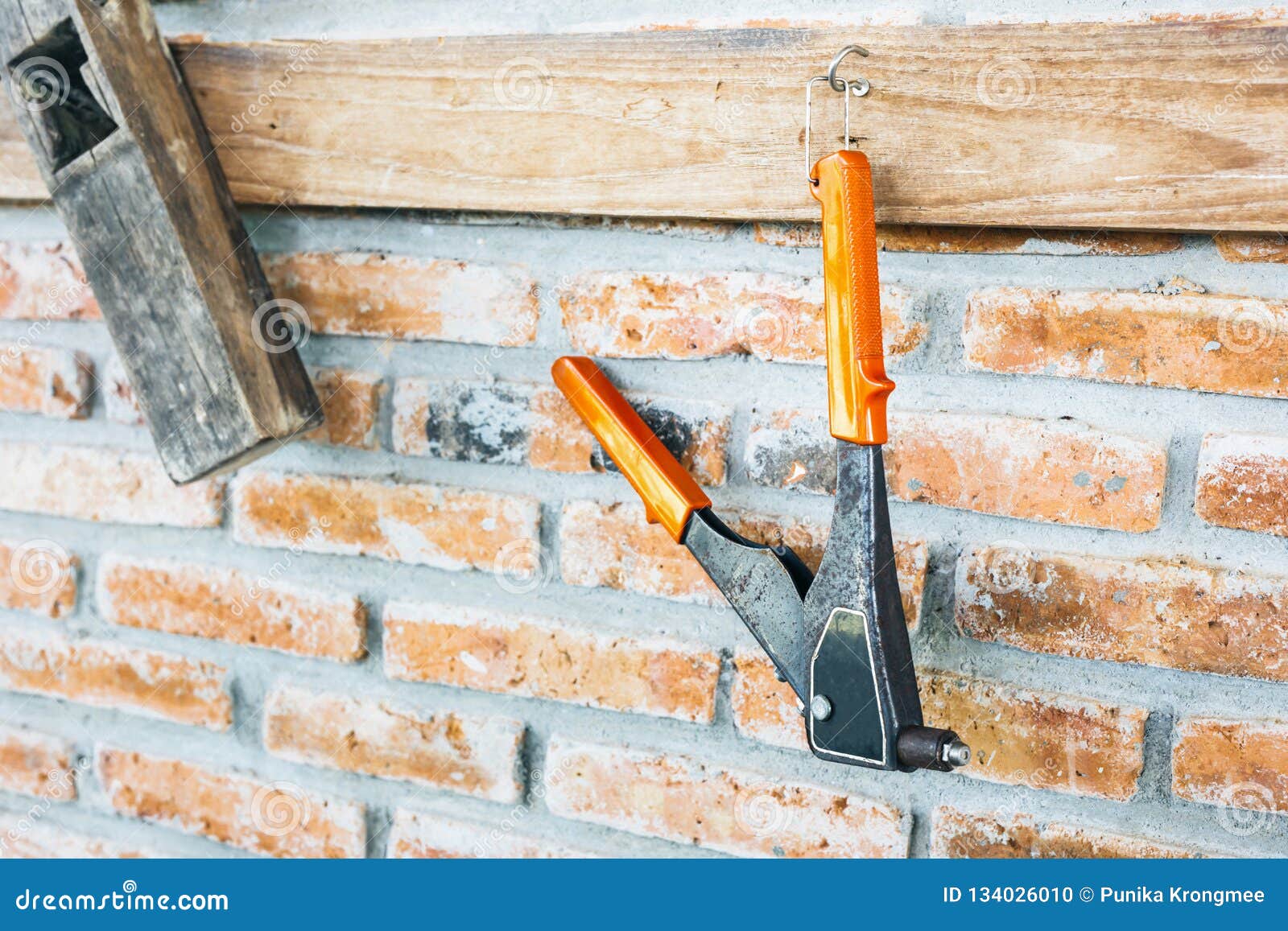 Construction Equipment Hang on the Brick Wall Stock Photo - Image of ...