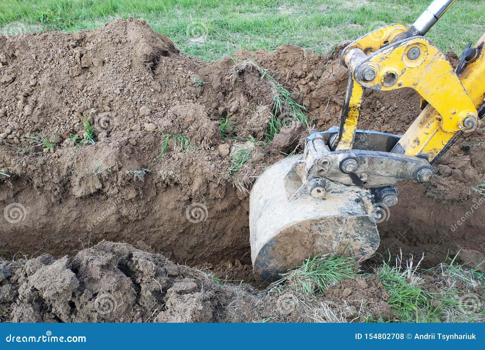 Construction Excavator Digging a Shallow Groove for Electrical Wiring ...