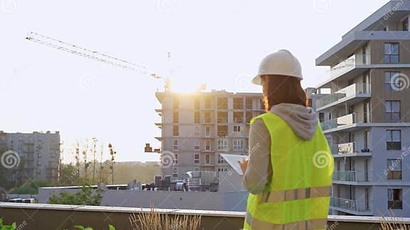 Construction Female Engineer Taking Notes and Tapping on Tablet ...