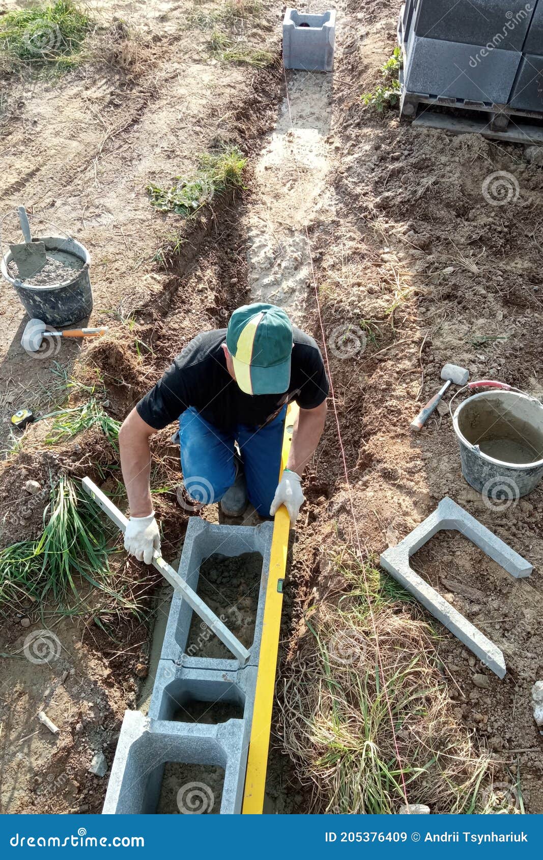 Construction of a Fence on a Private Territory, a Worker while ...