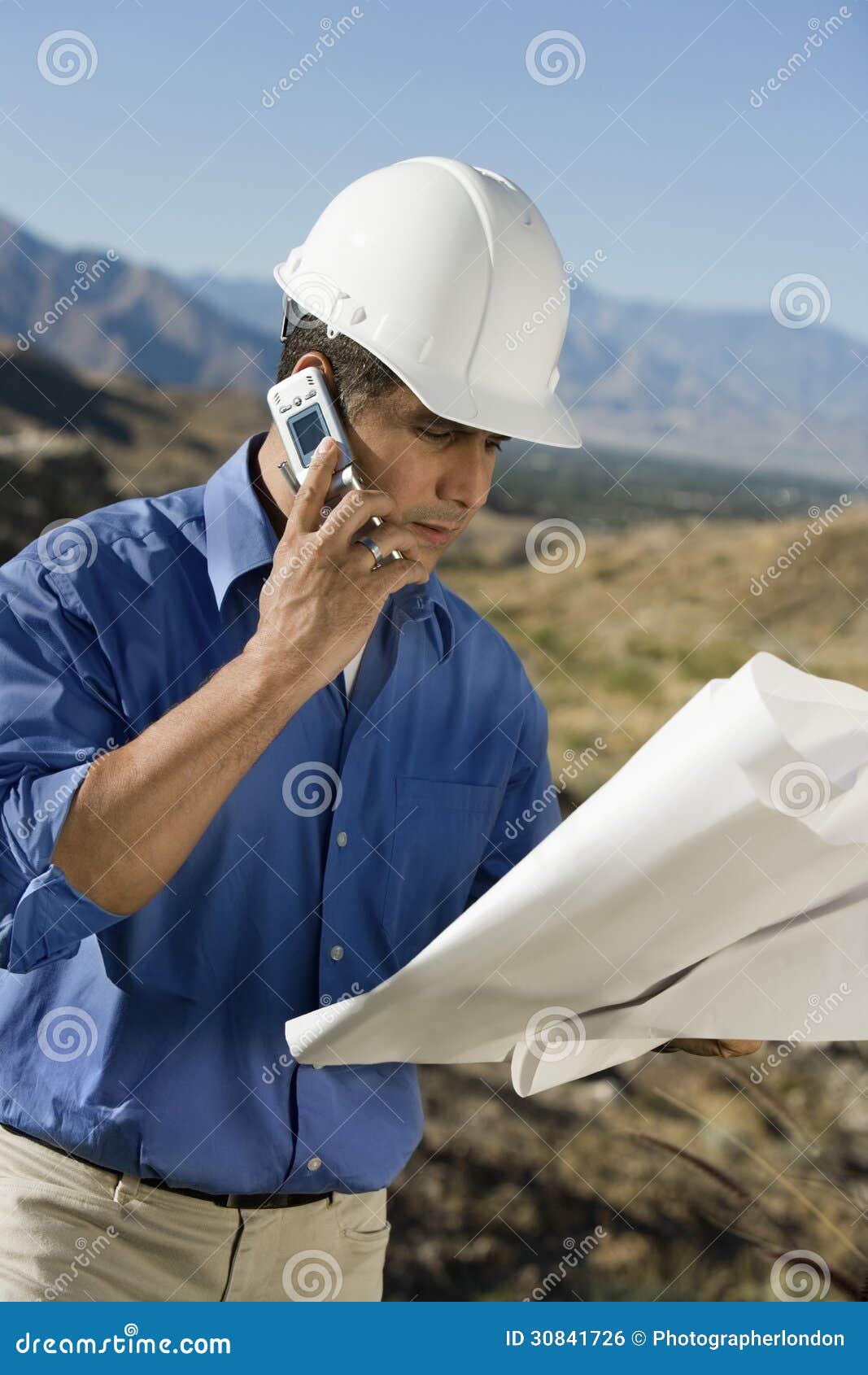 Construction Foreman with Cellphone and Blue Print on Site Stock Photo ...