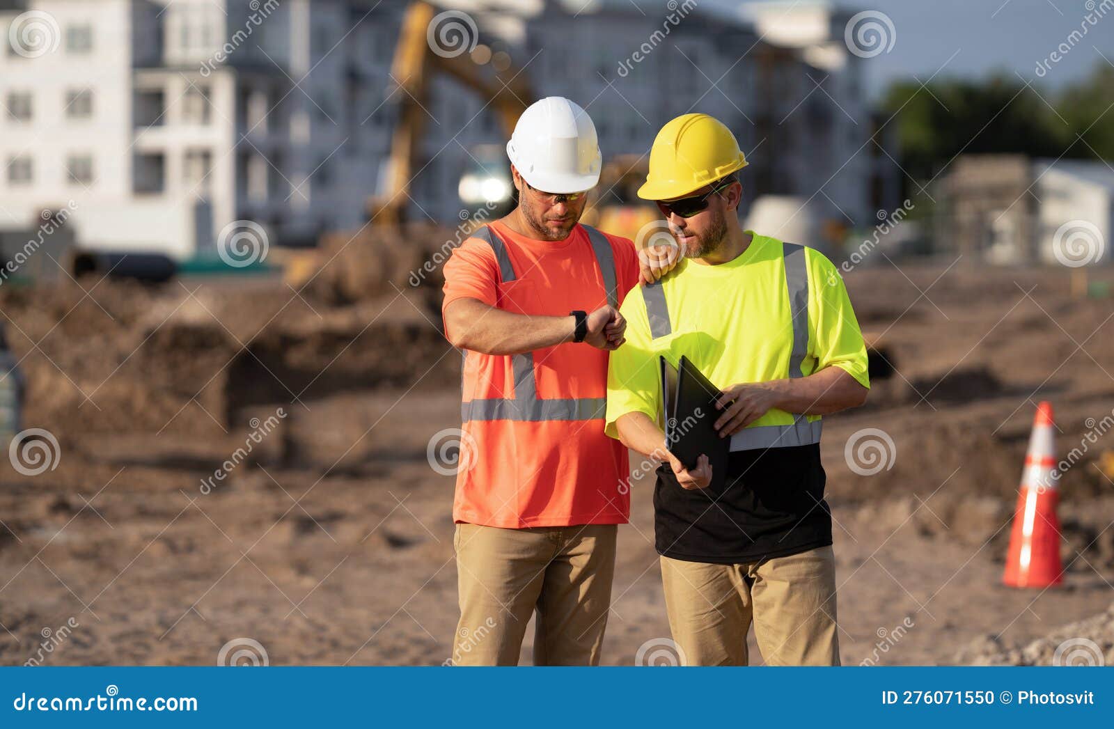 Construction Foreman and Civil Engineer at Work Checking Time Schedule ...