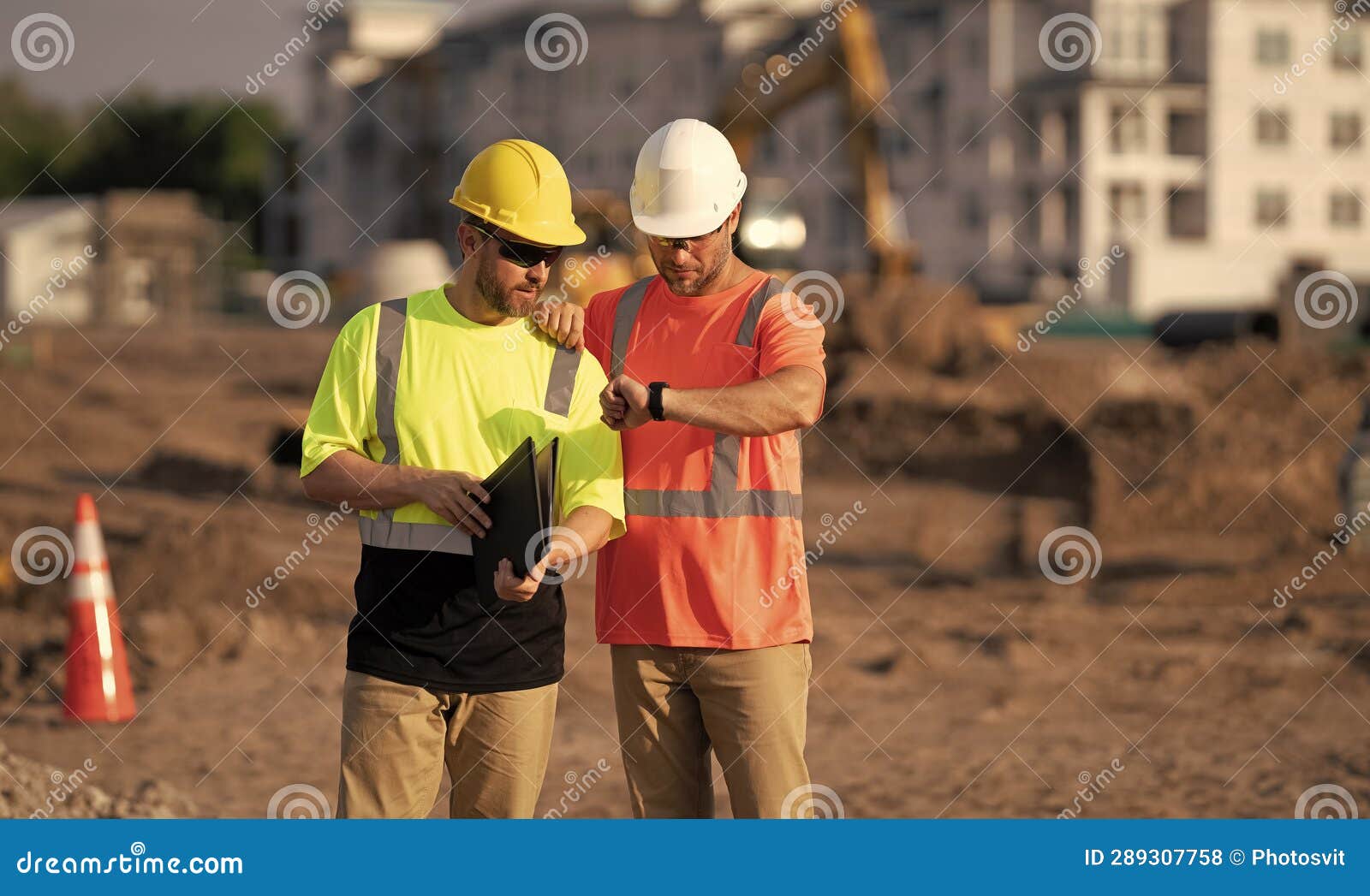 Construction Foreman and Civil Engineer at Work Checking Time Schedule ...