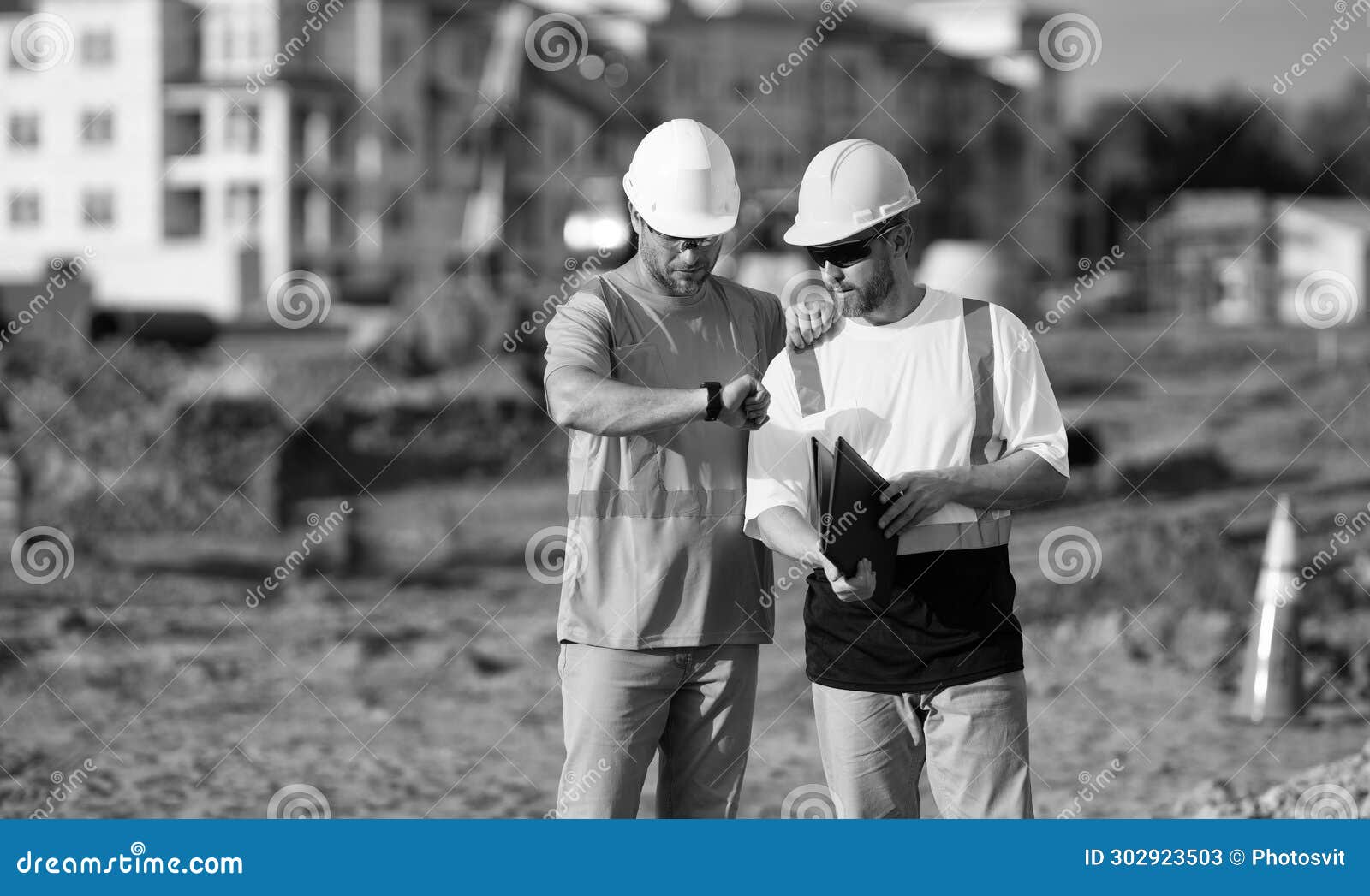 Construction Foreman and Civil Engineer at Work Checking Time Schedule ...