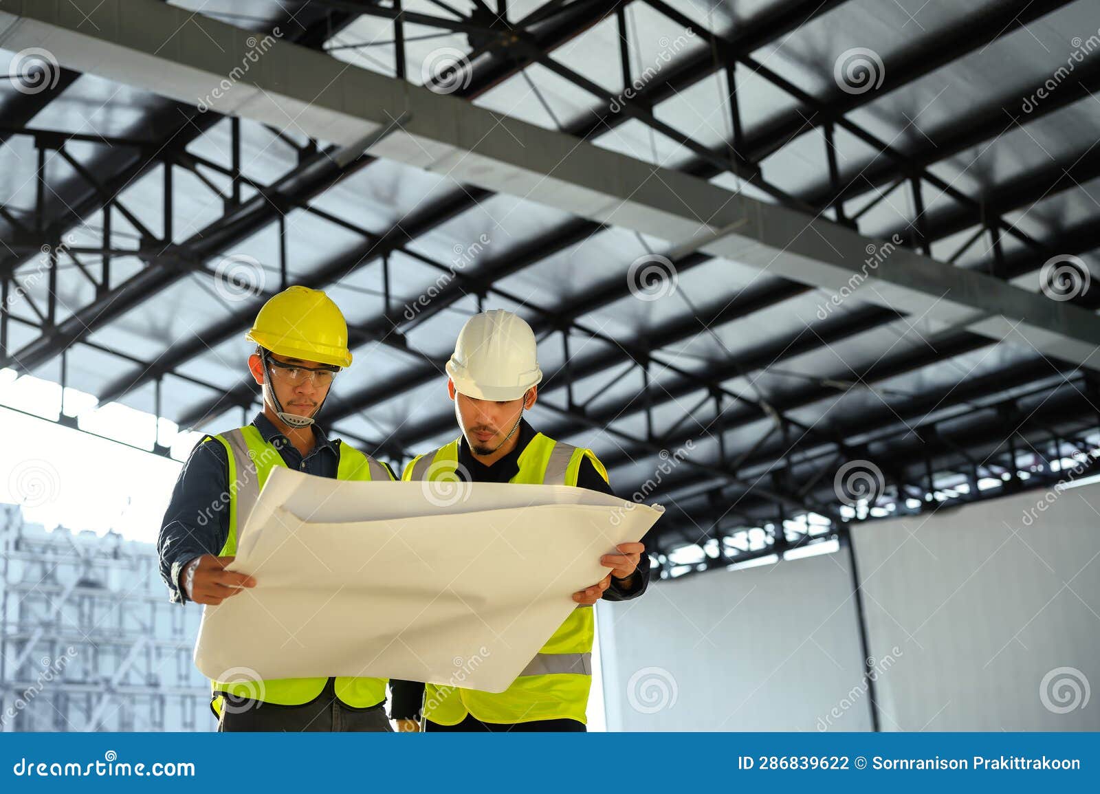 Construction Foreman and Engineers Two People Discuss and Look at the ...