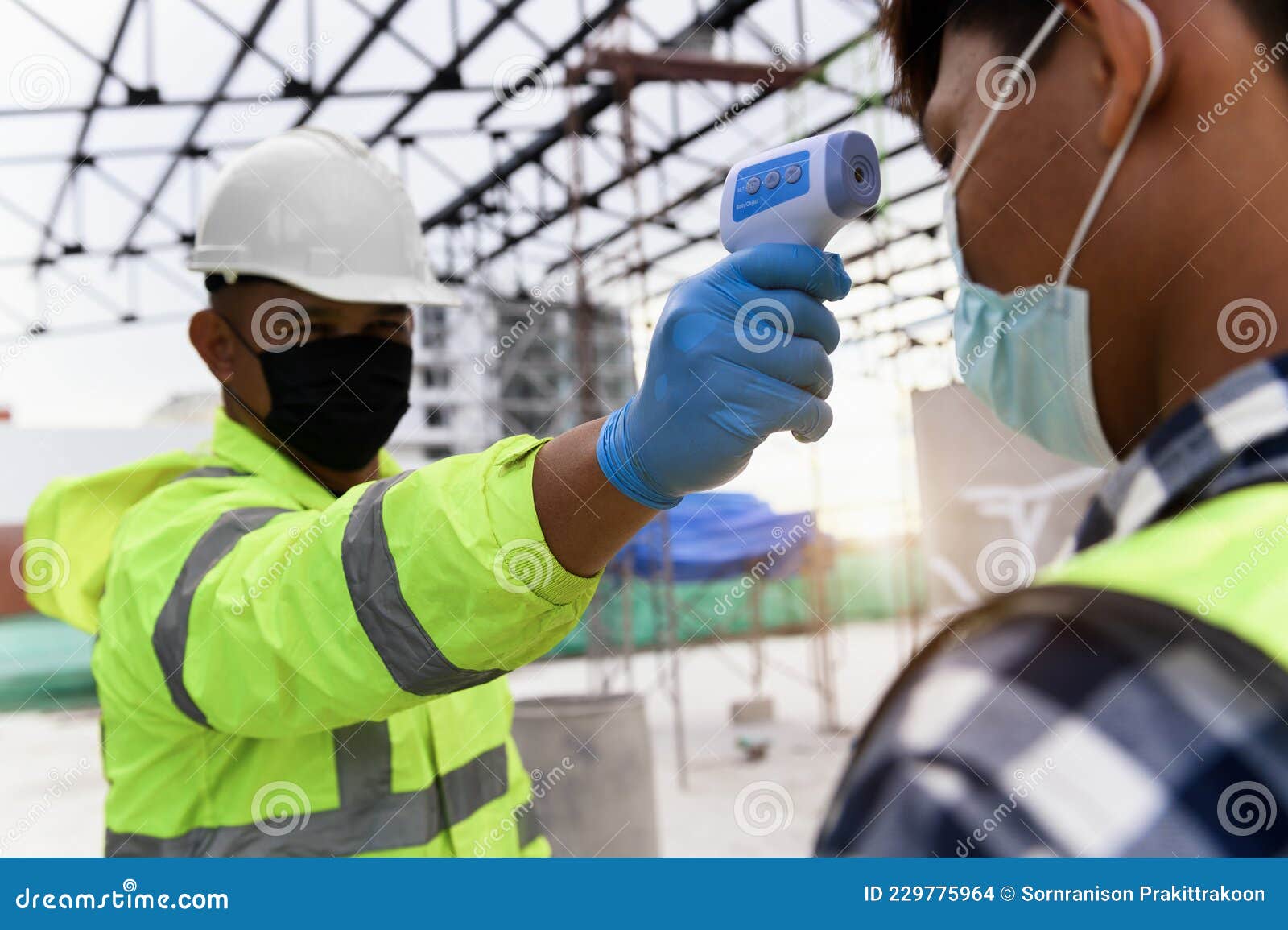 Screening Body Temperature of Worker with Infrared Thermometer Stock ...
