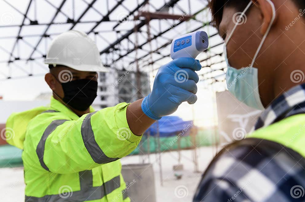 Screening Body Temperature of Worker with Infrared Thermometer Stock ...