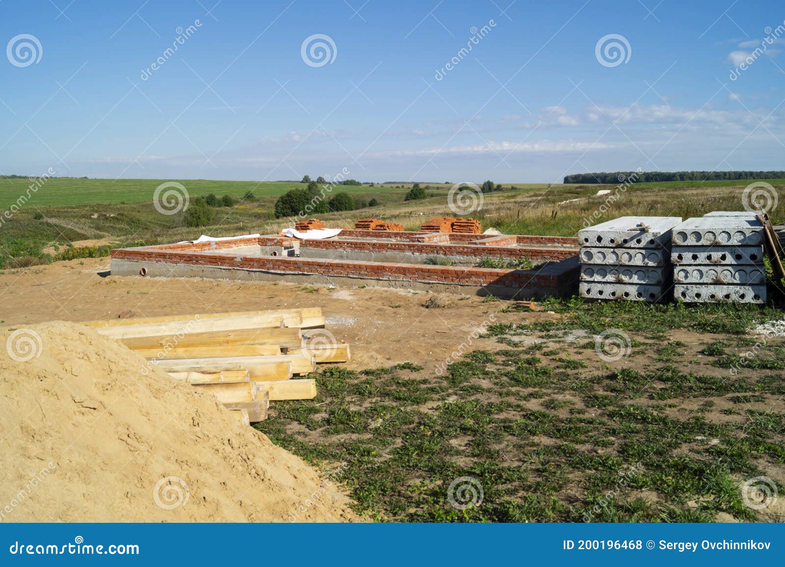 Construction of the Foundation for Building in Field on Background Blue ...