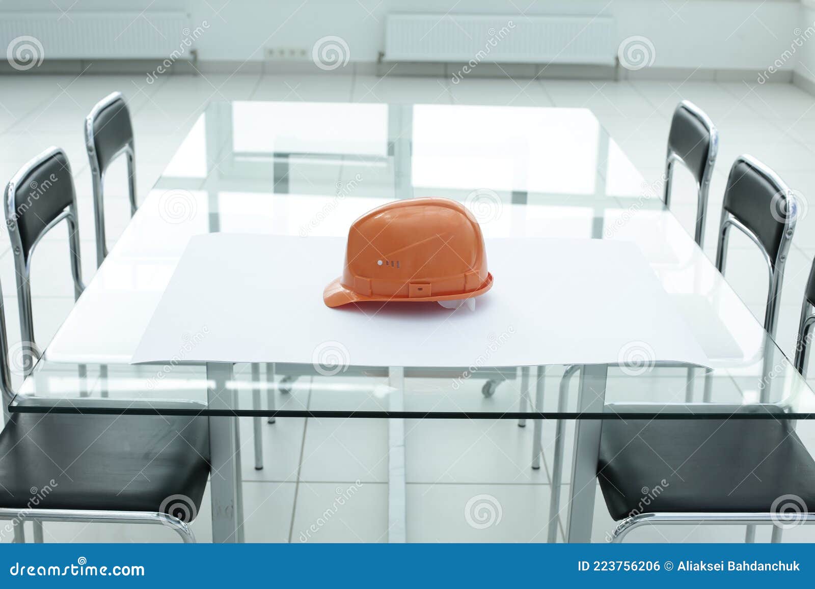 Construction Hard Hat and Blueprints on Glass Table in Office Space ...