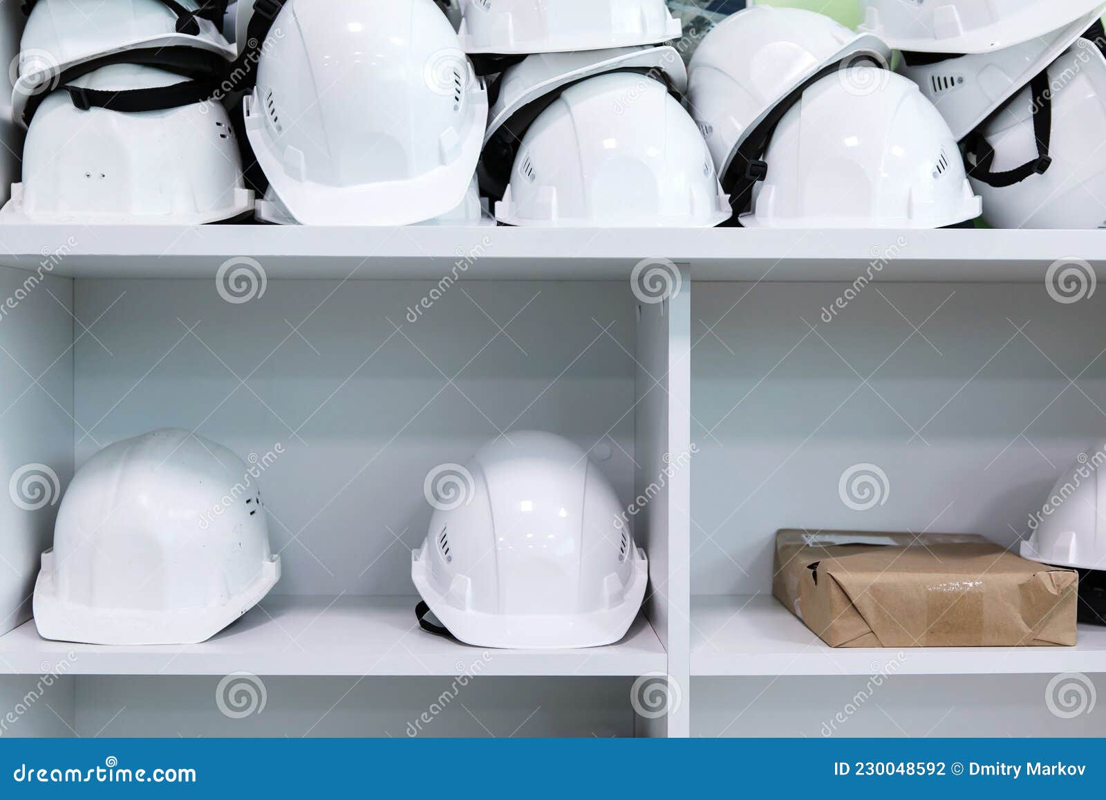 Construction Helmets Lie on a Shelf in the Factory Locker Room. Safety ...