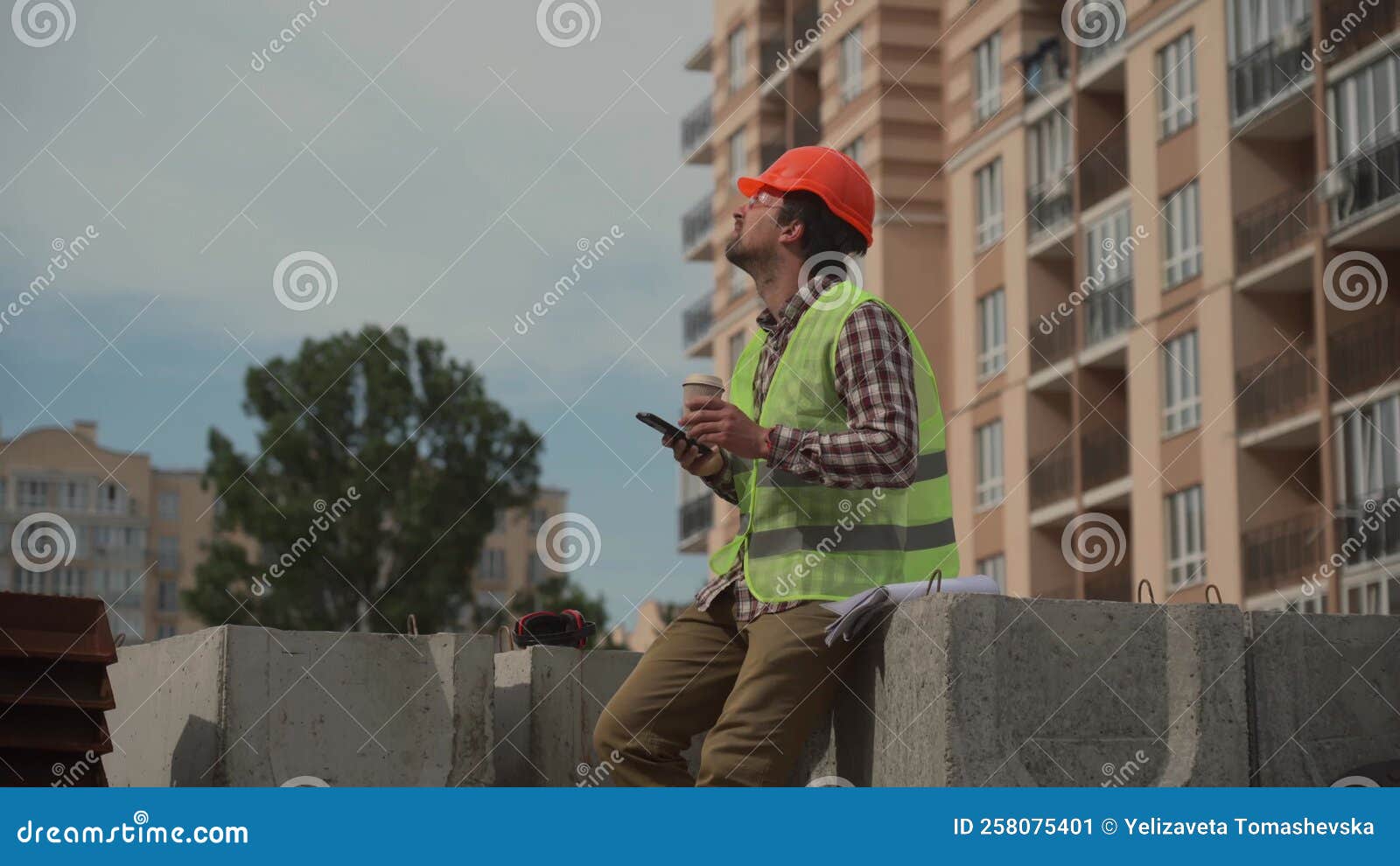 Construction Industry Worker Texting during Lunch Break. Helmeted ...