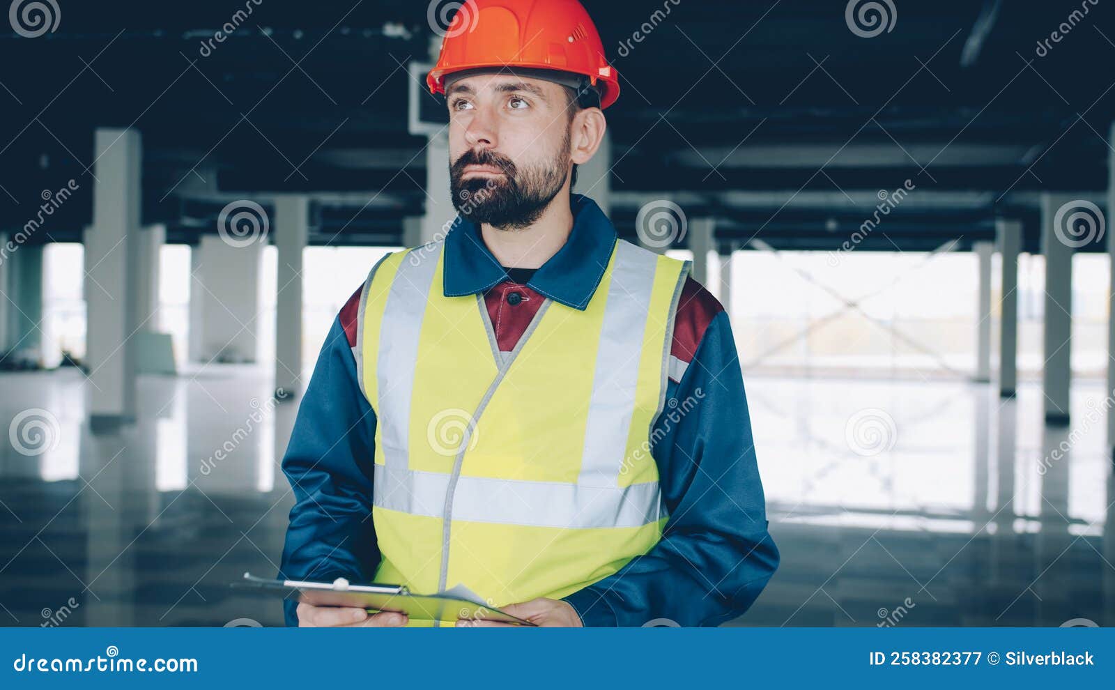 Construction Inspector Checking Papers and Studying Industrial Building ...