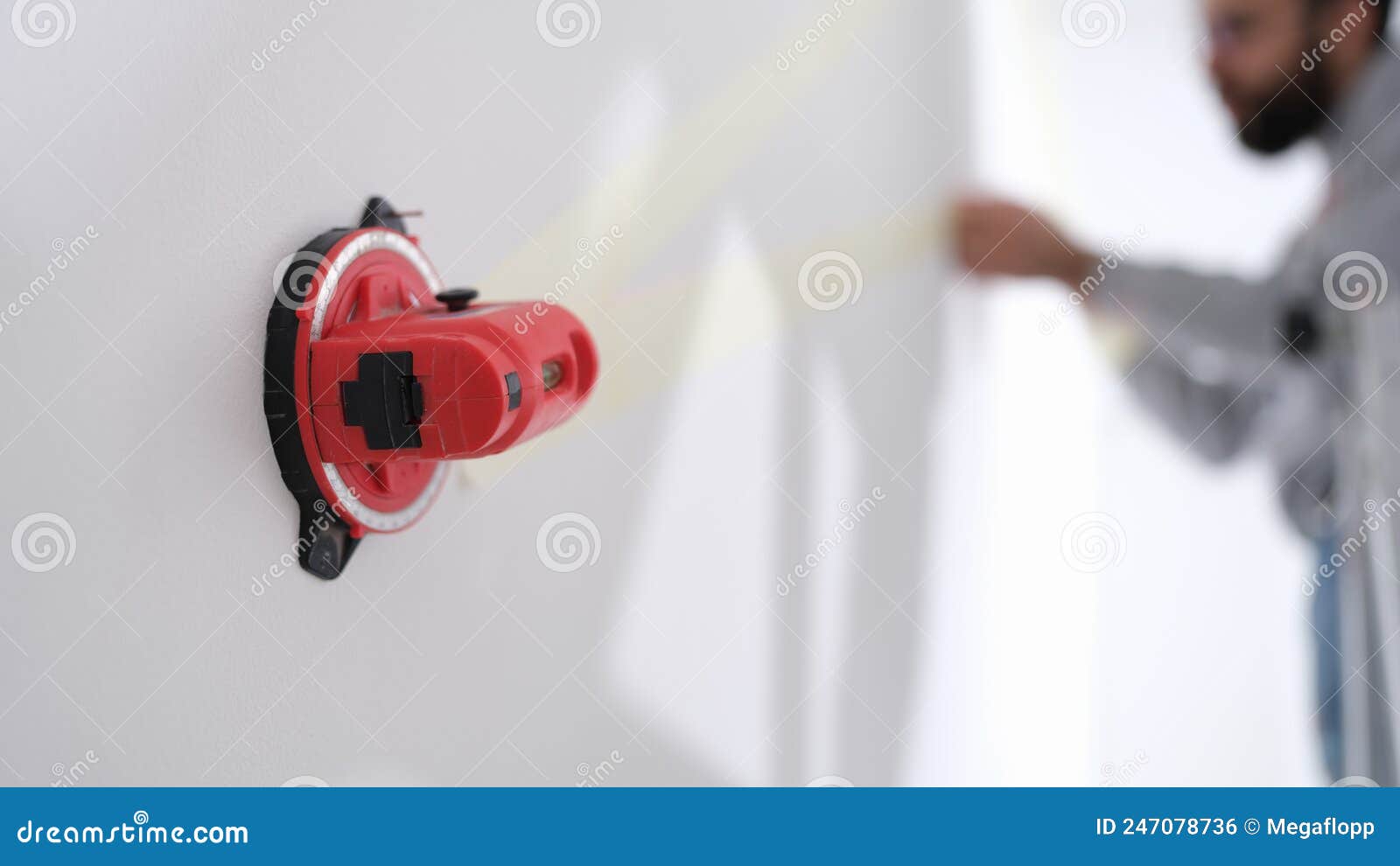 Construction Laser Level is Fixed on Wall. Builder Makes Repairs in ...