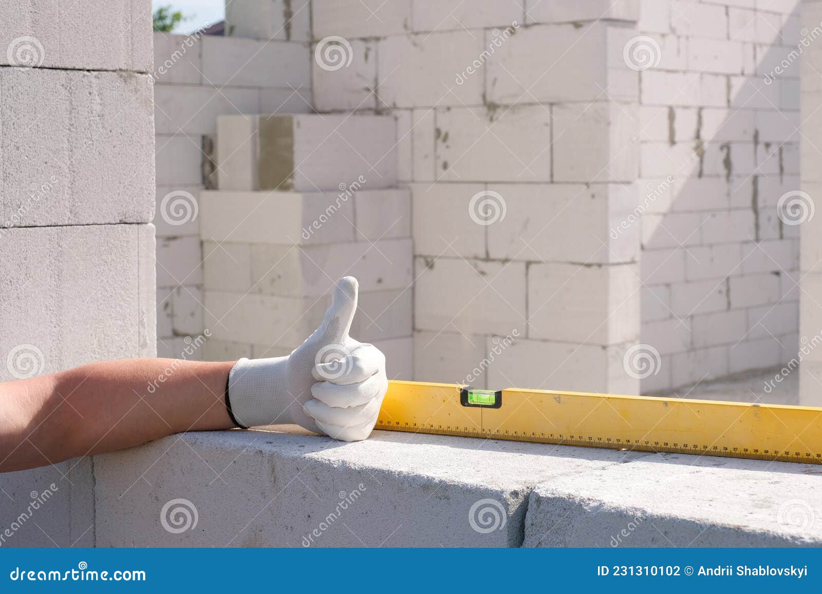 Construction Level and Hands of the Builder at the Construction Site ...