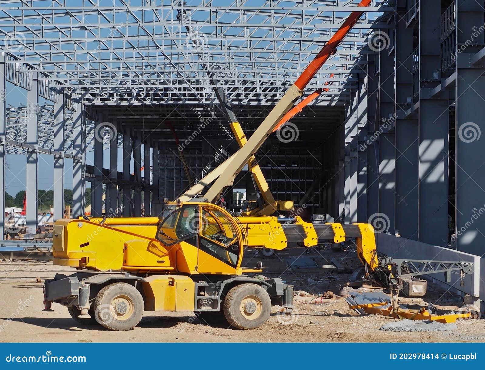 Construction Machineries at Work Inside the Metallic Frame of a Large ...