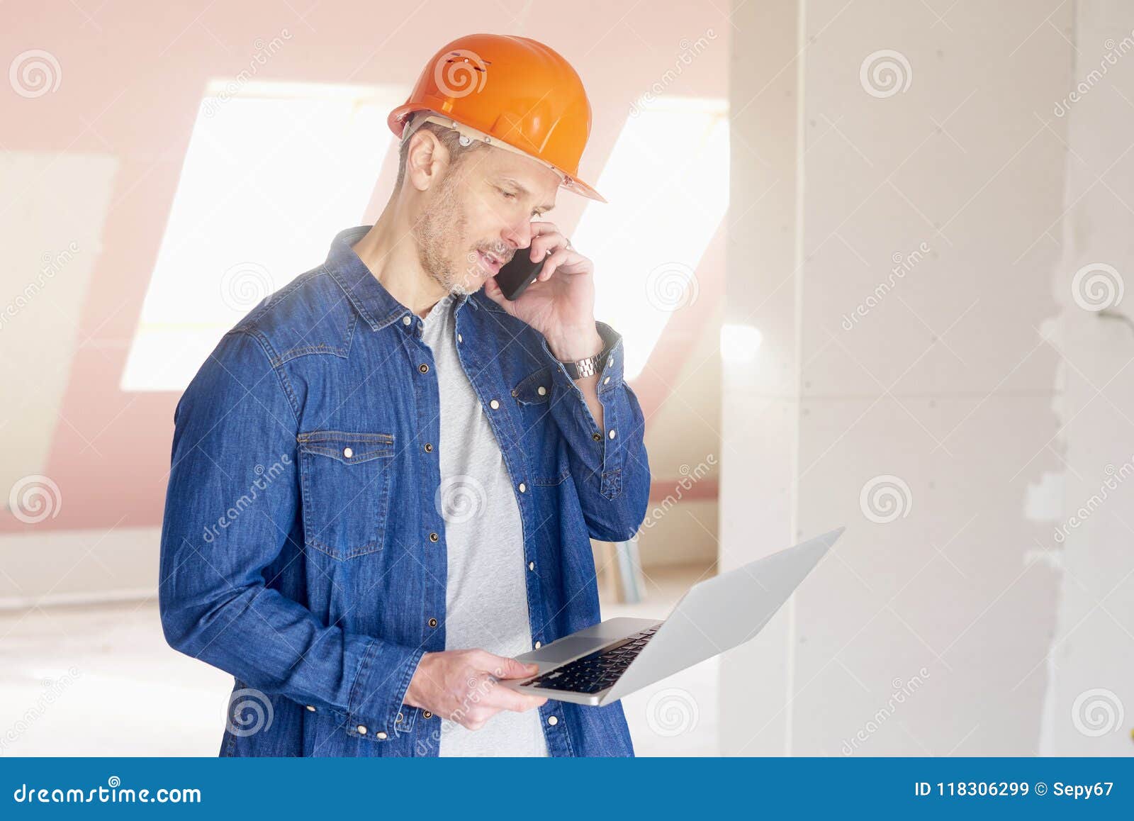 Construction Worker Using Laptop and Mobile Phone Stock Image - Image ...