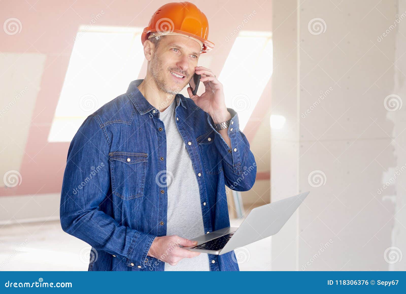 Construction Worker Using Laptop and Mobile Phone Stock Photo - Image ...